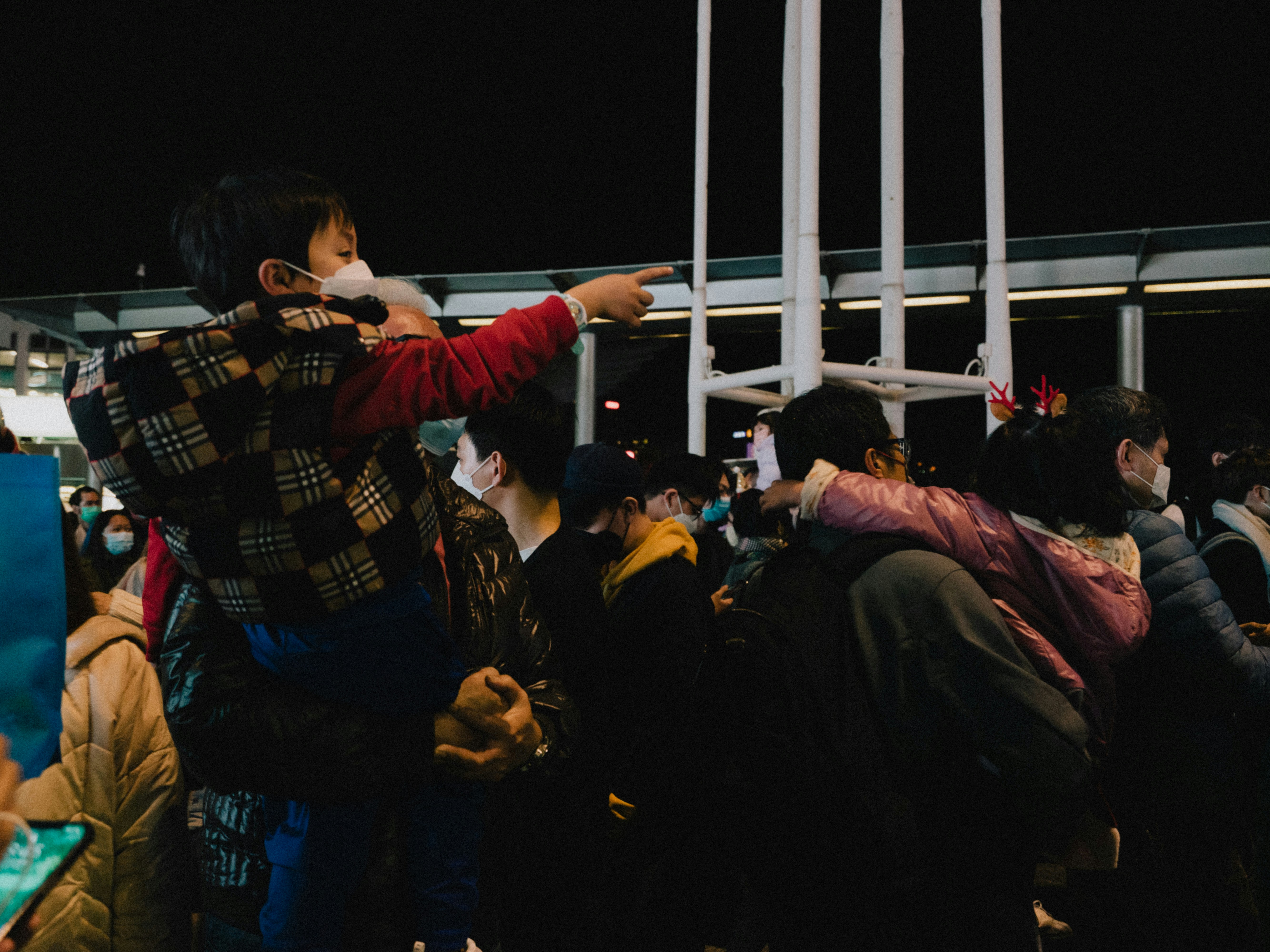 a crowd of people standing around each other