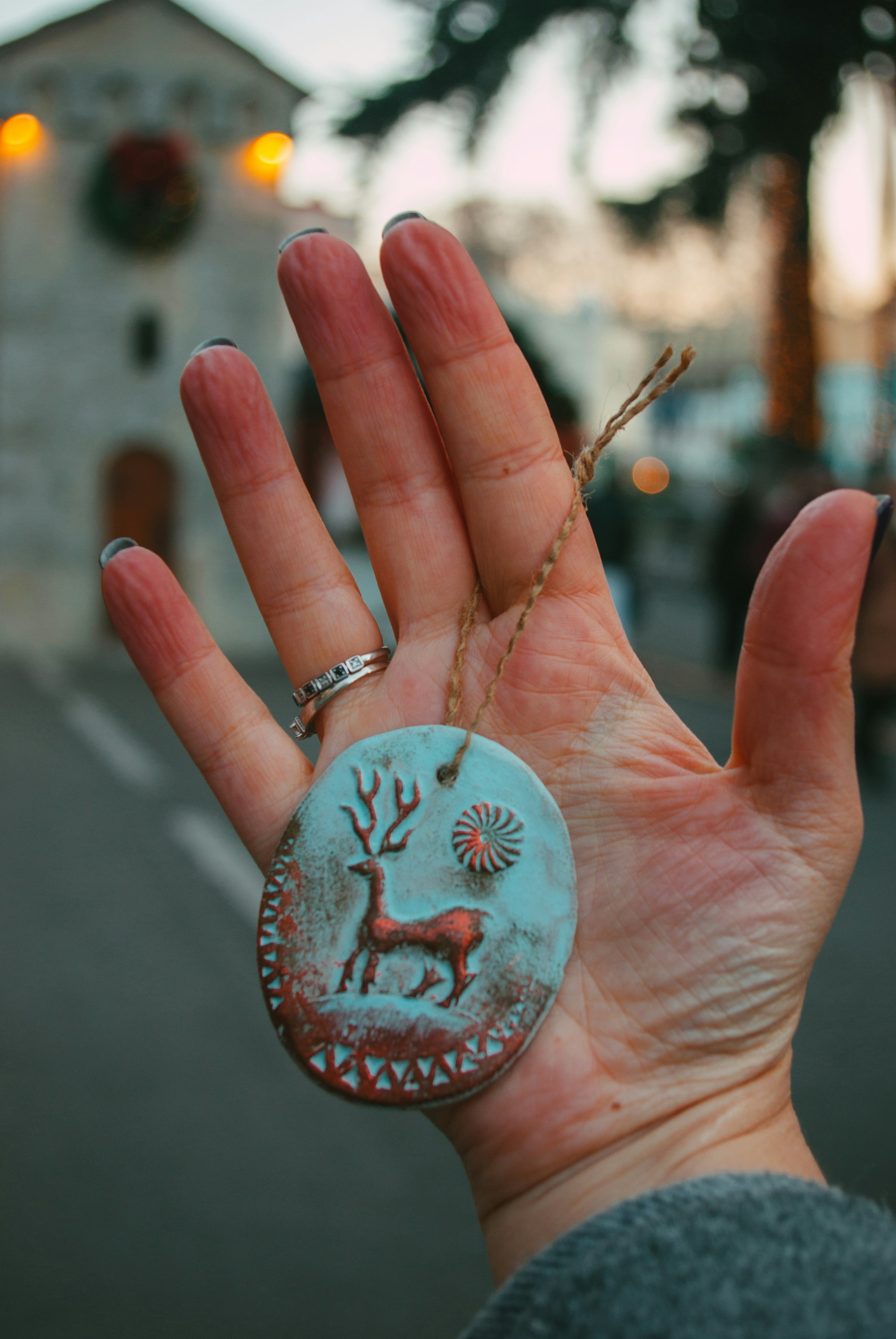 Hand-held Ornament: A Frosted Deersilhouette Pendant in Focus