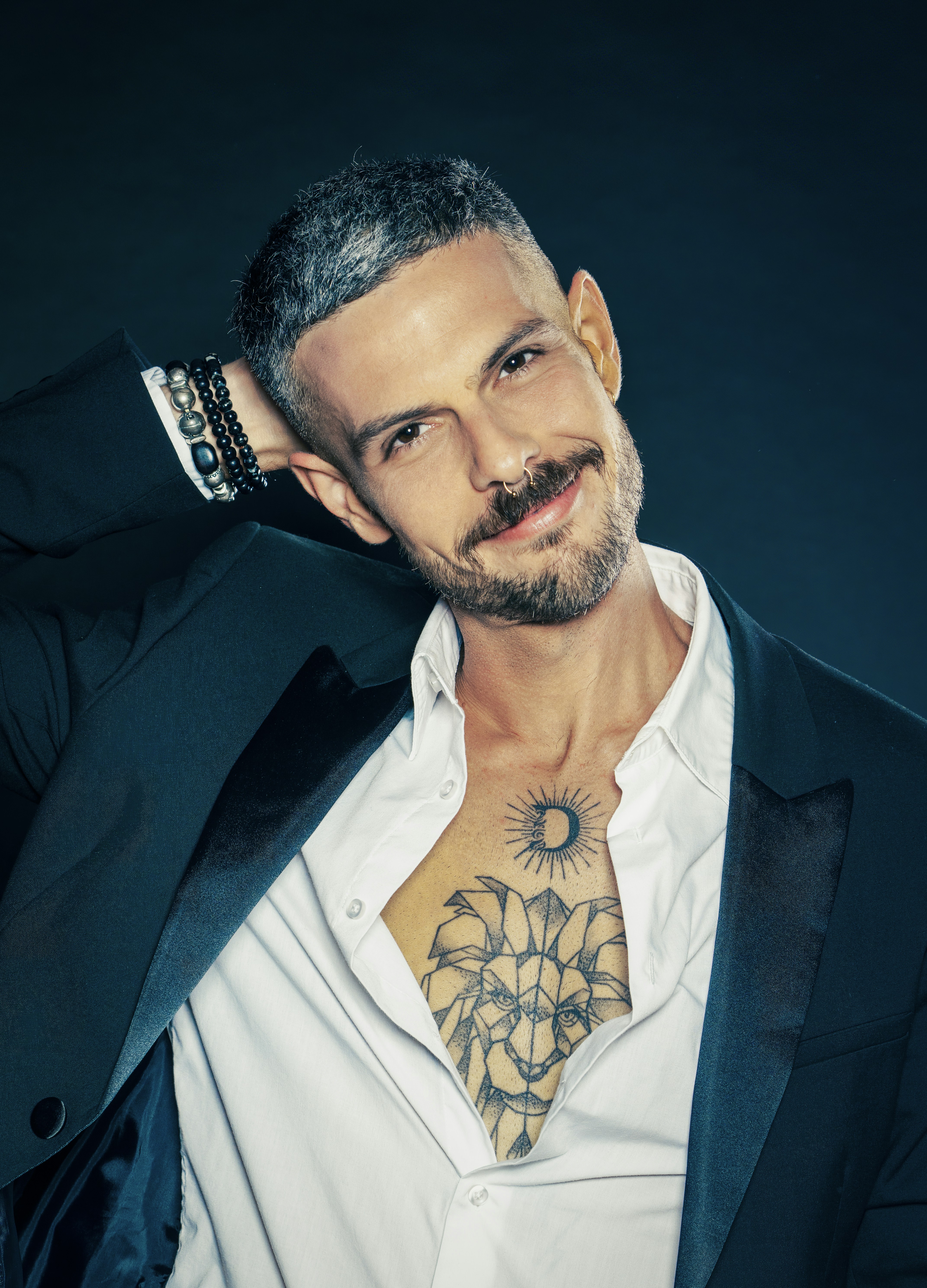 A man with a tattoo on his chest posing for a picture photo – Free ...
