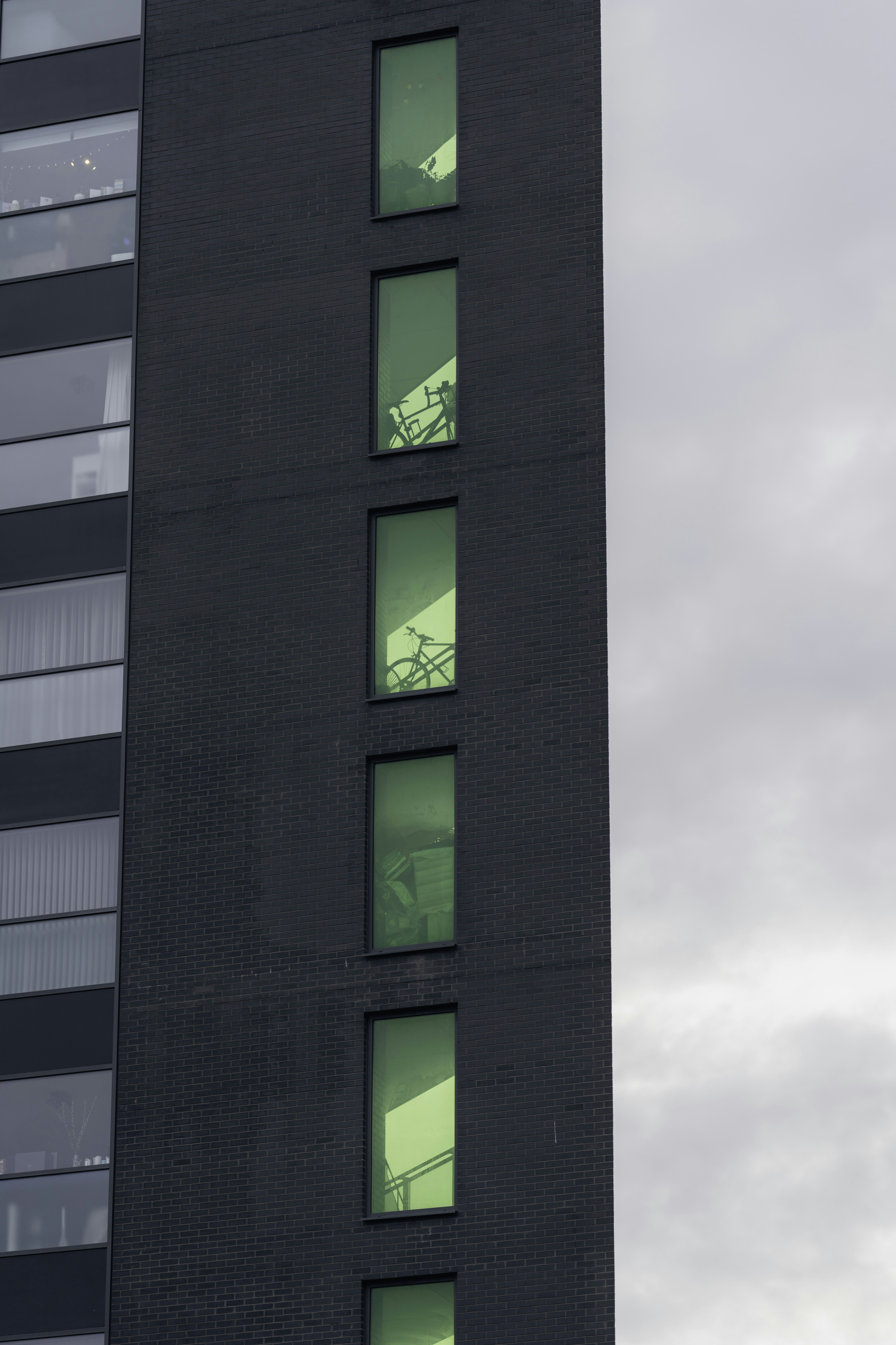 A tall black building with lots of windows photo – Free City Image on ...