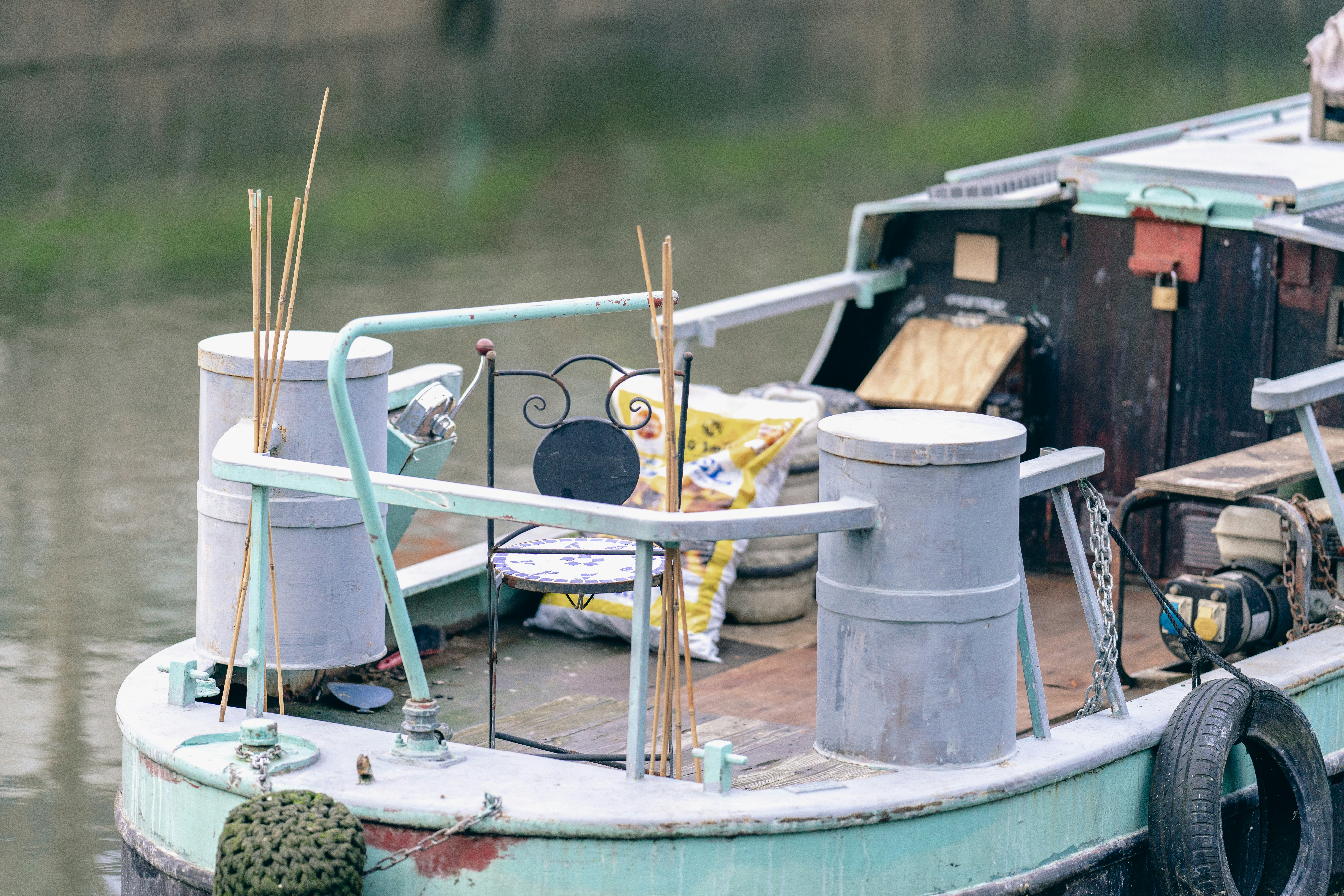 Barge Deck Jumble: Tools, Poles, and Ropes in Quiet Harbor