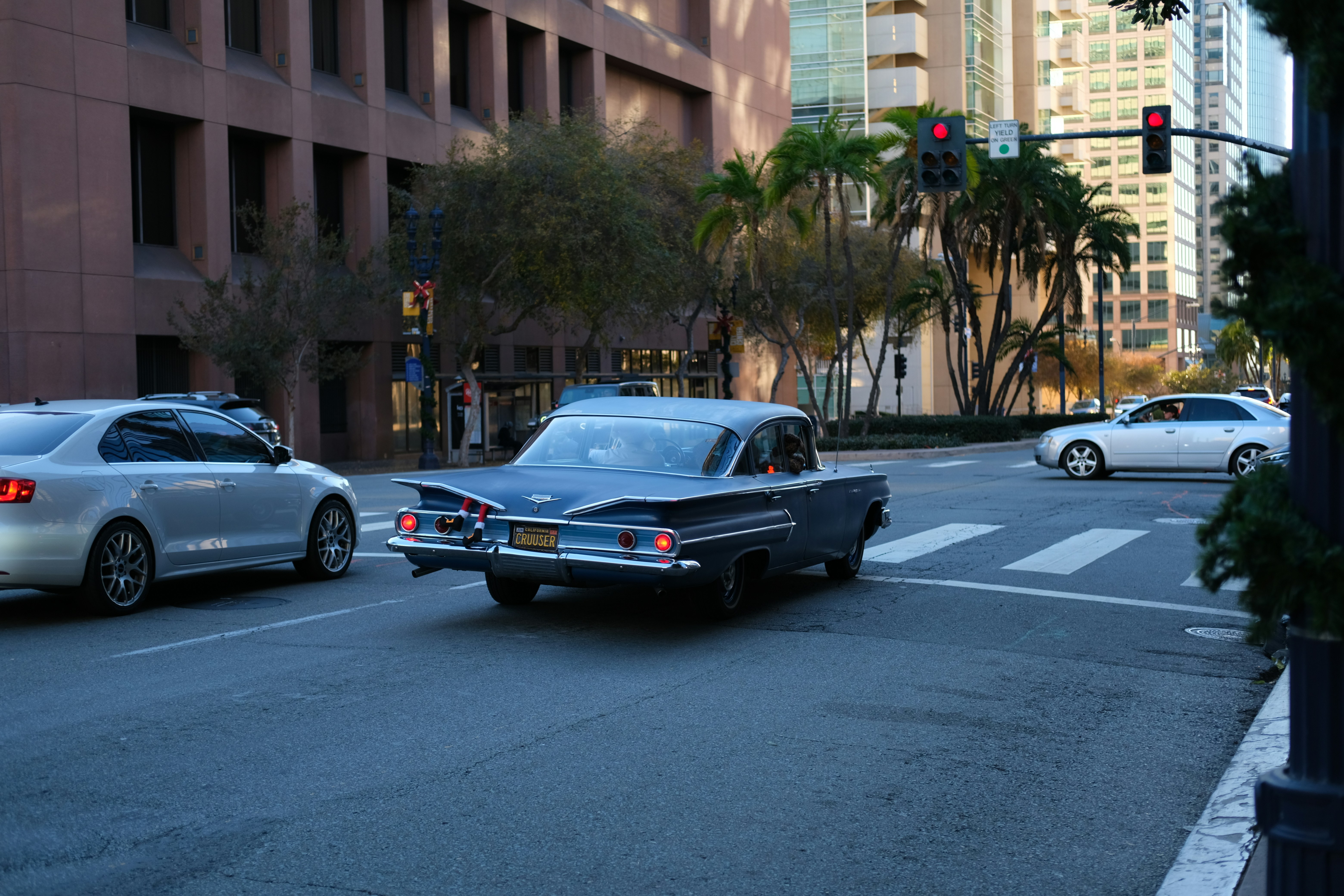 Blue Chrome at Dusk: A Vintage Car Navigates a Quiet Downtown Crossing