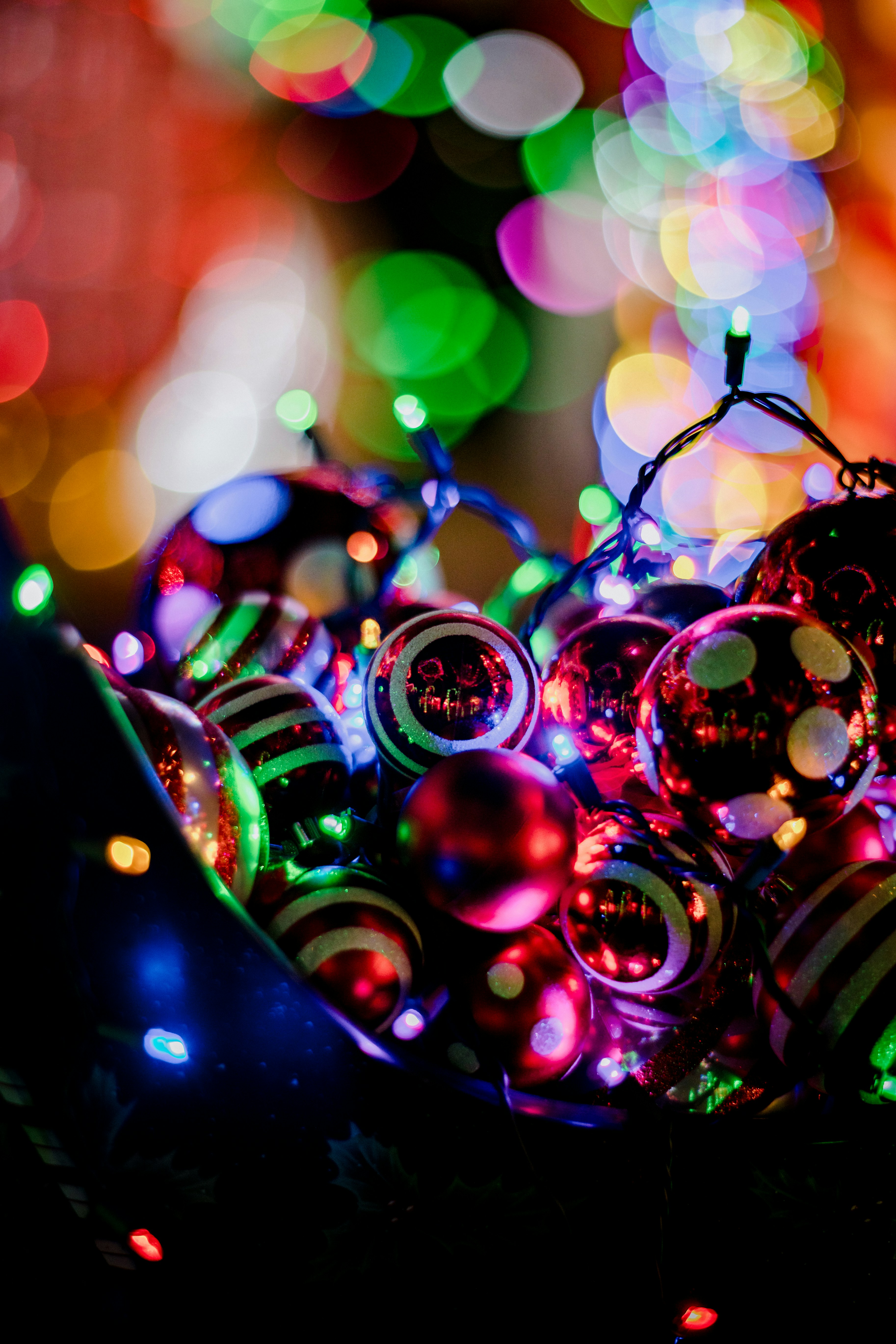 Neon Ornaments and Velvet Bokeh: A Cluster of Christmas Light Reflections