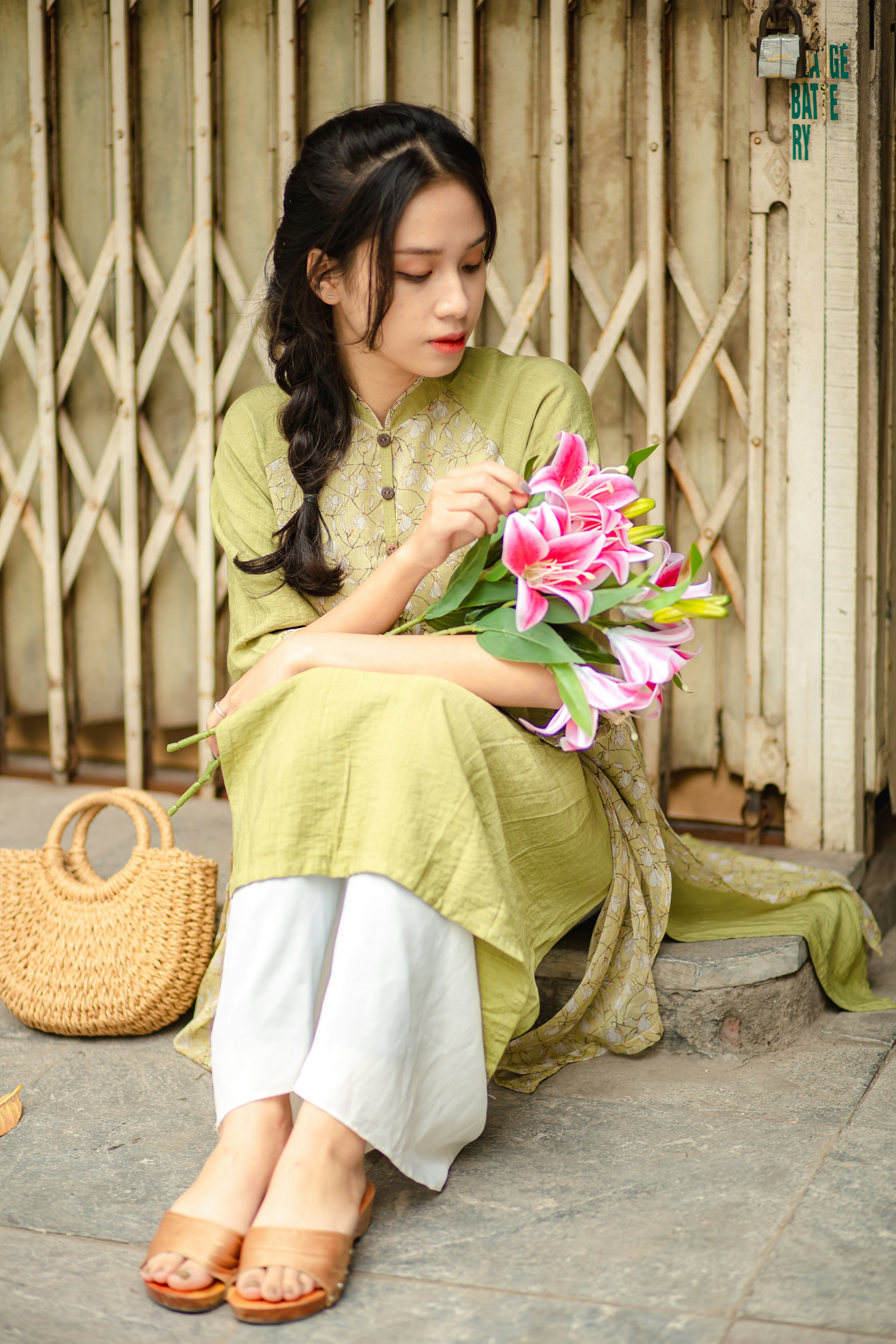 Petals by the Gate: A Quiet Portrait in Olive Linen