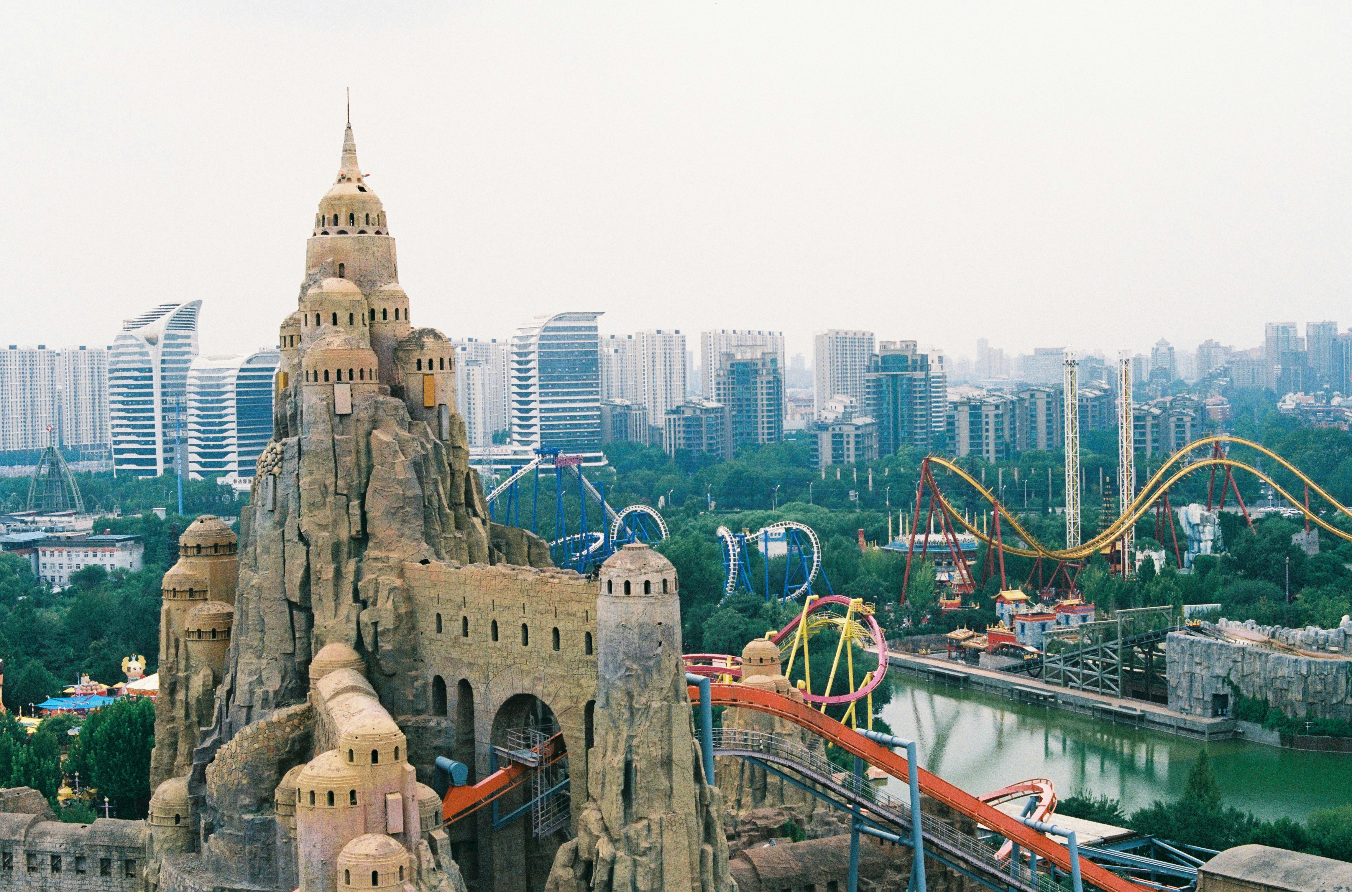 Granite Citadel Over a Sea of Coasters and a Distant Skyline
