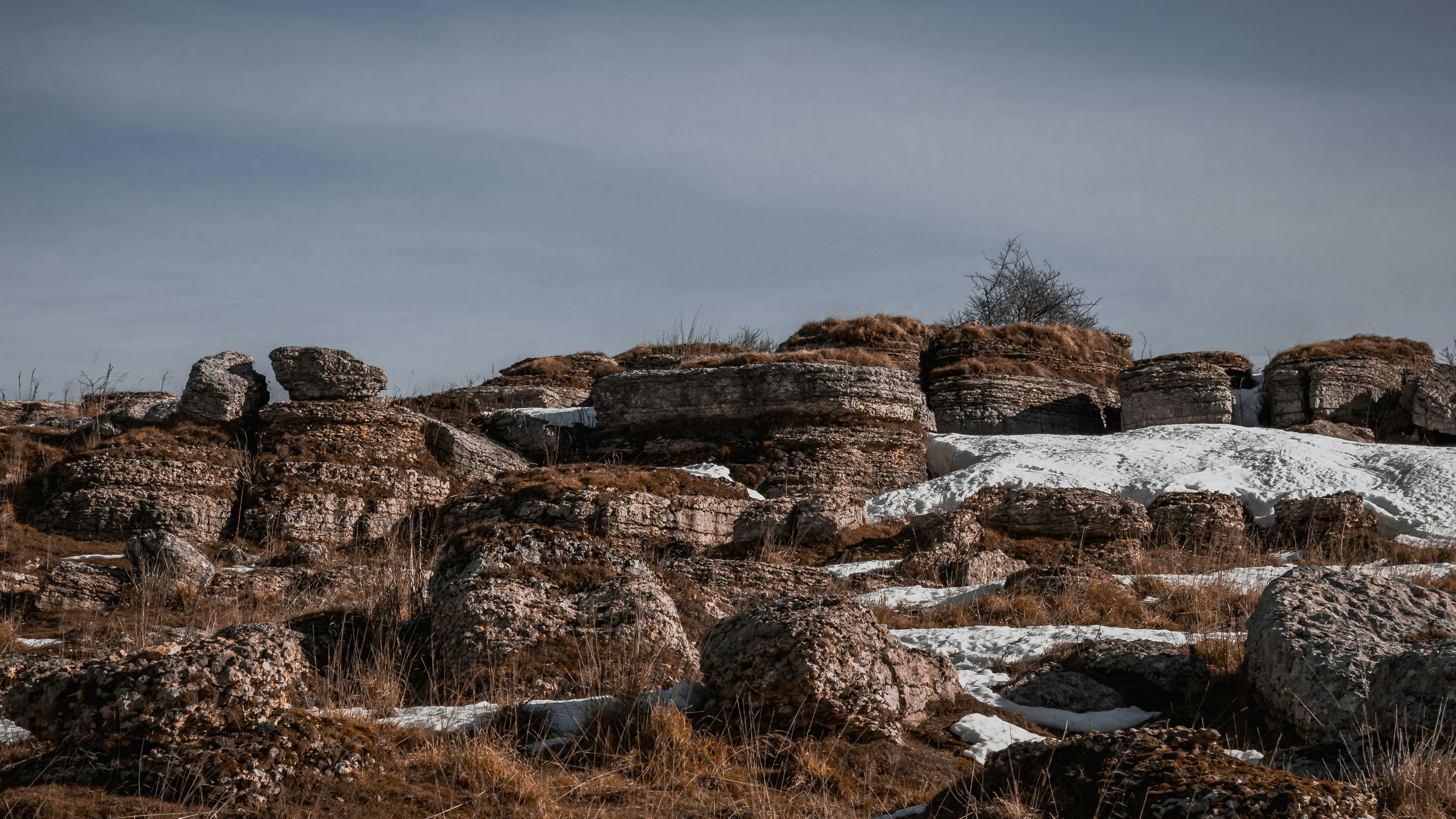 Snow-Dusted Giants: Weathered Boulders Under a Quiet Blue Sky