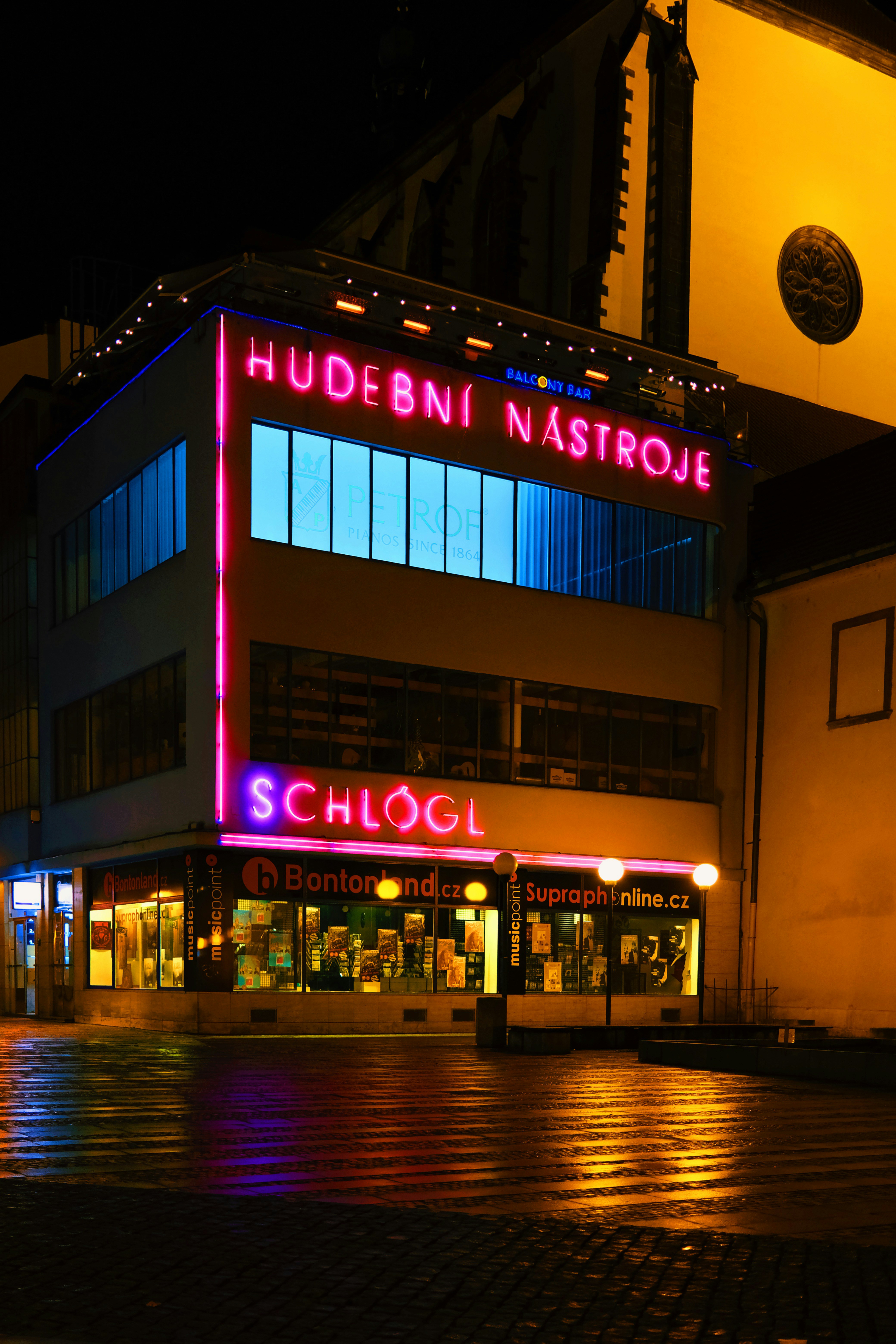 A building that has a neon sign on it photo – Free Praha Image on Unsplash
