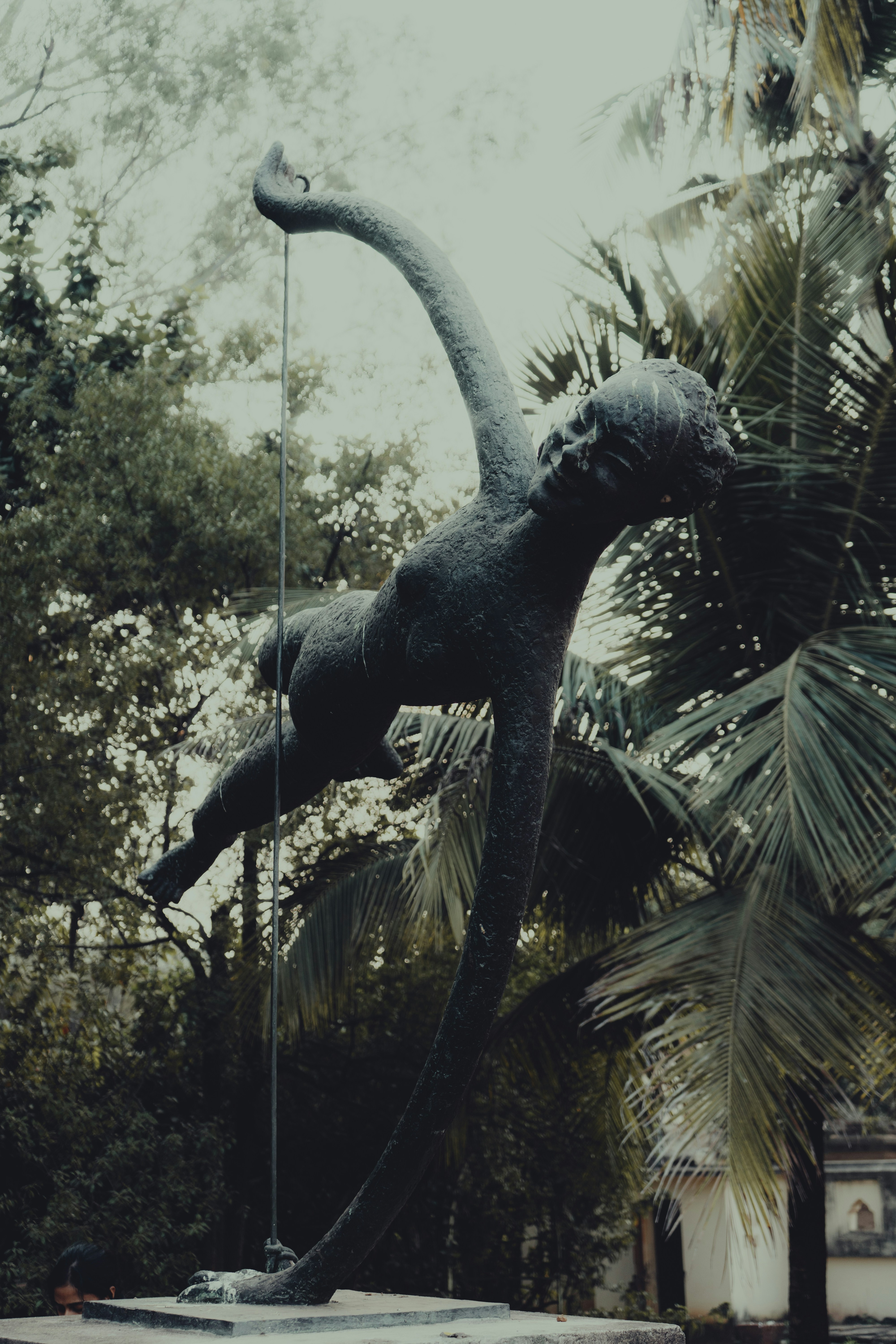 a statue of a dinosaur in a park