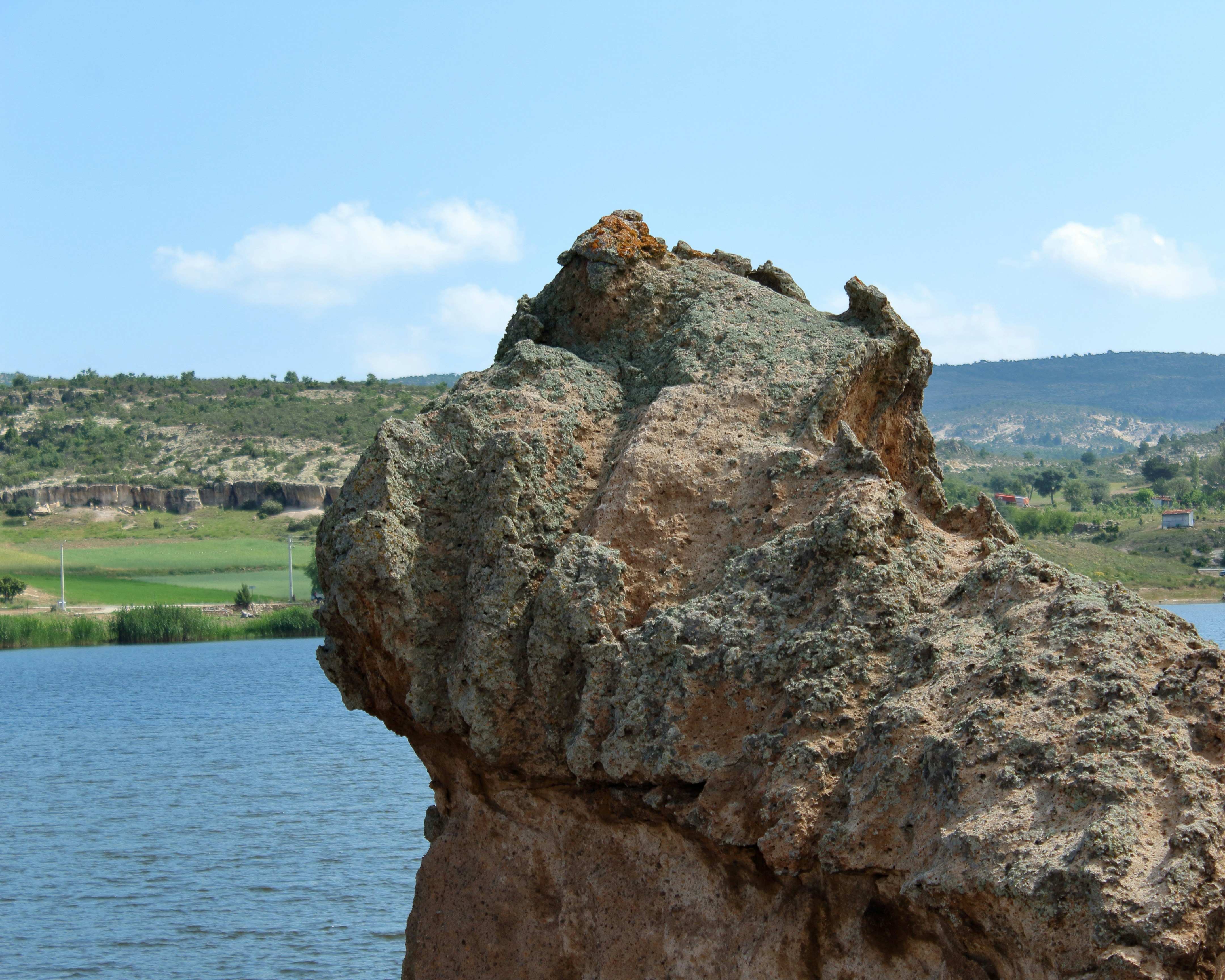 Lone Tusk of Stone Guarding a Quiet Lake