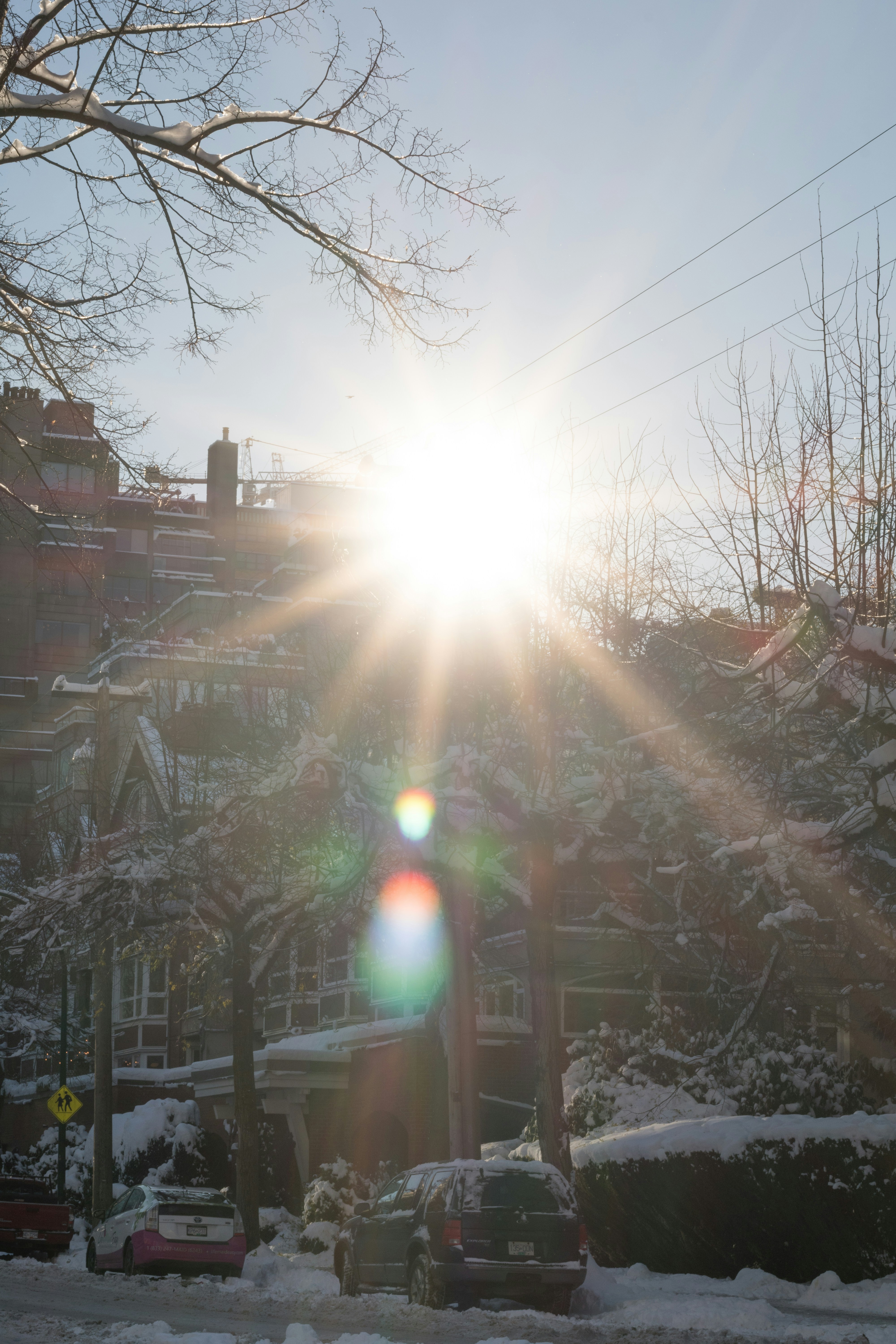 Dawn Solar Burst Over a Snow-Covered City Street