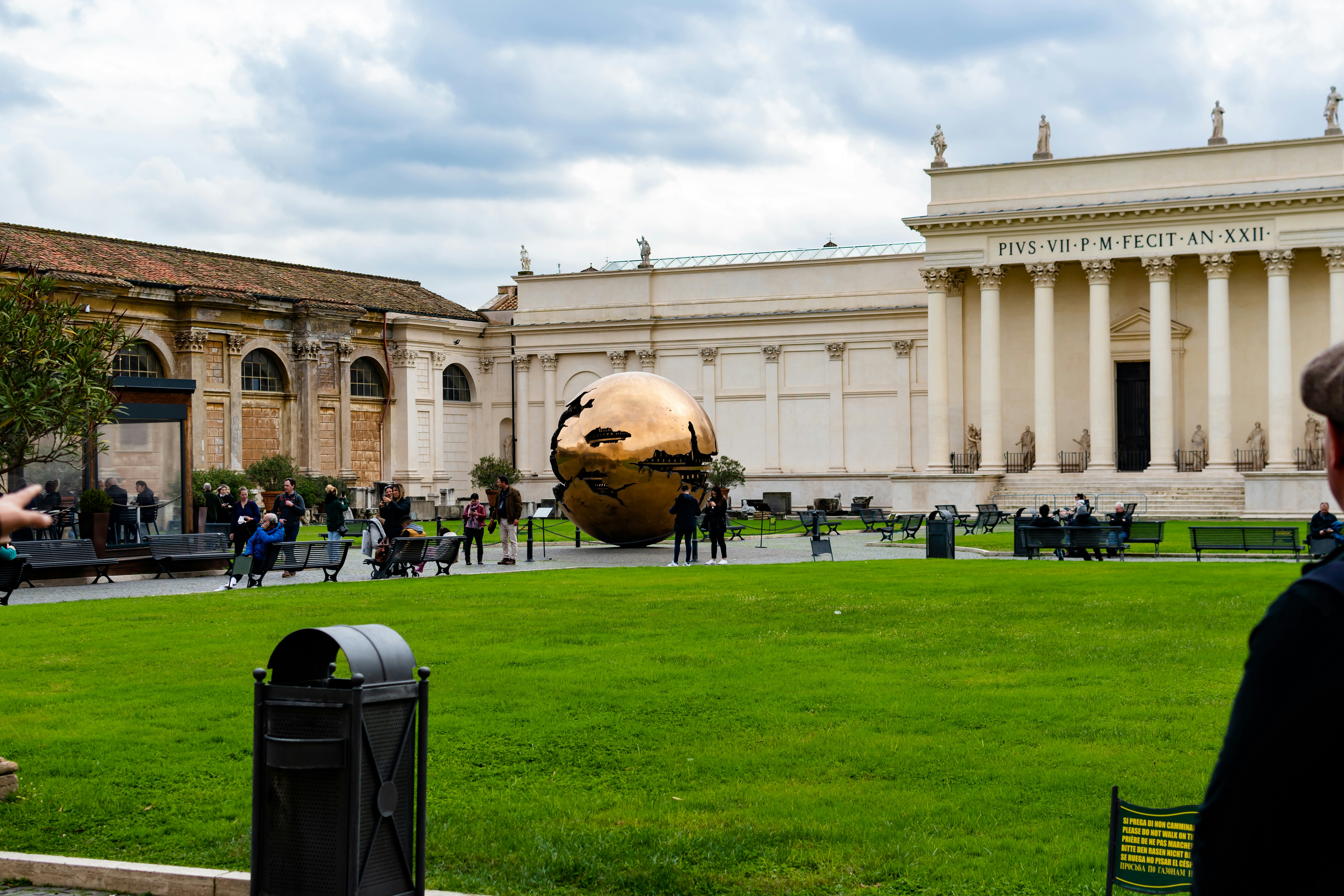 A man standing in front of a giant golden ball photo – Free Vaticano ...