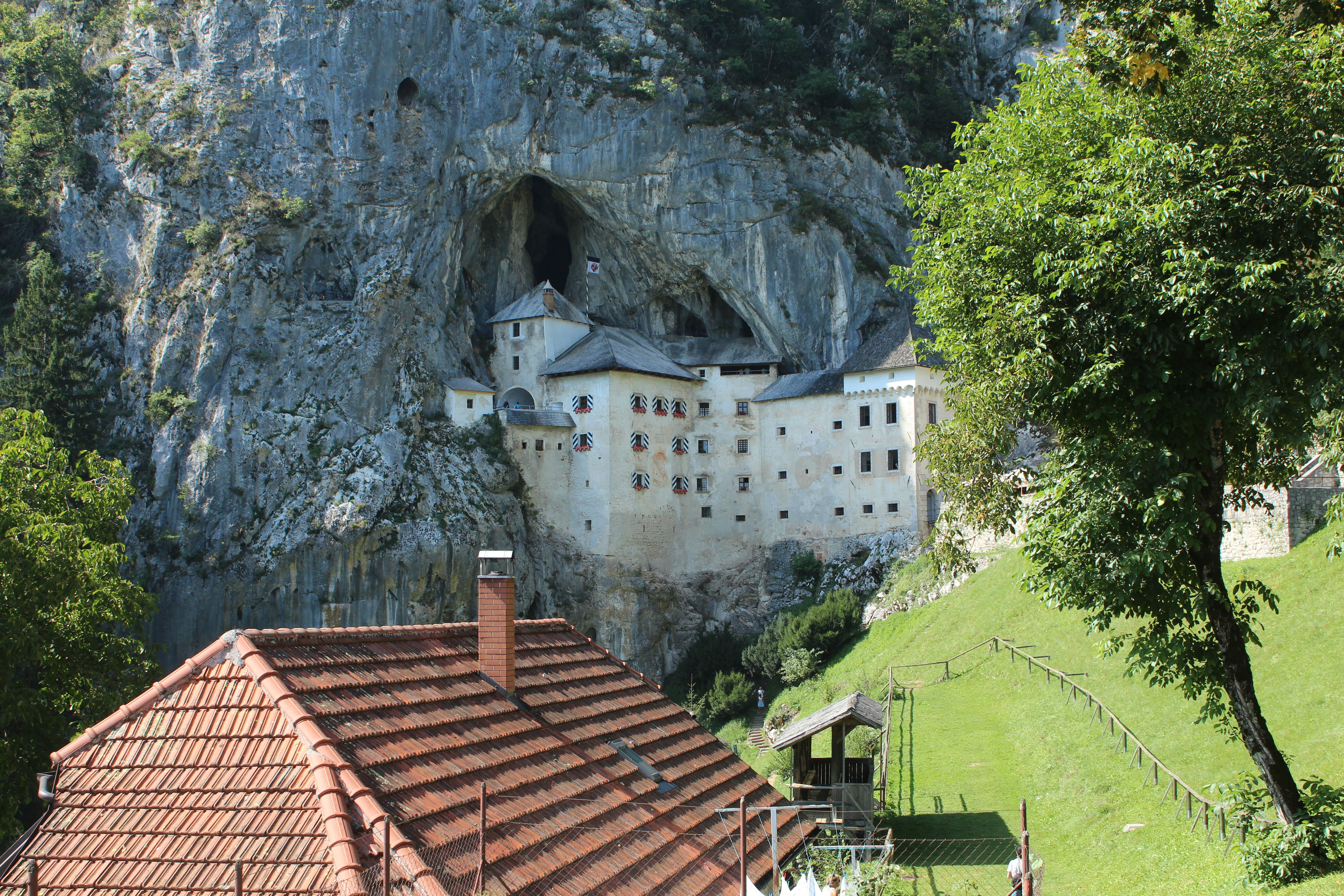 a castle built into the side of a mountain photo – Free Slovenia Image ...