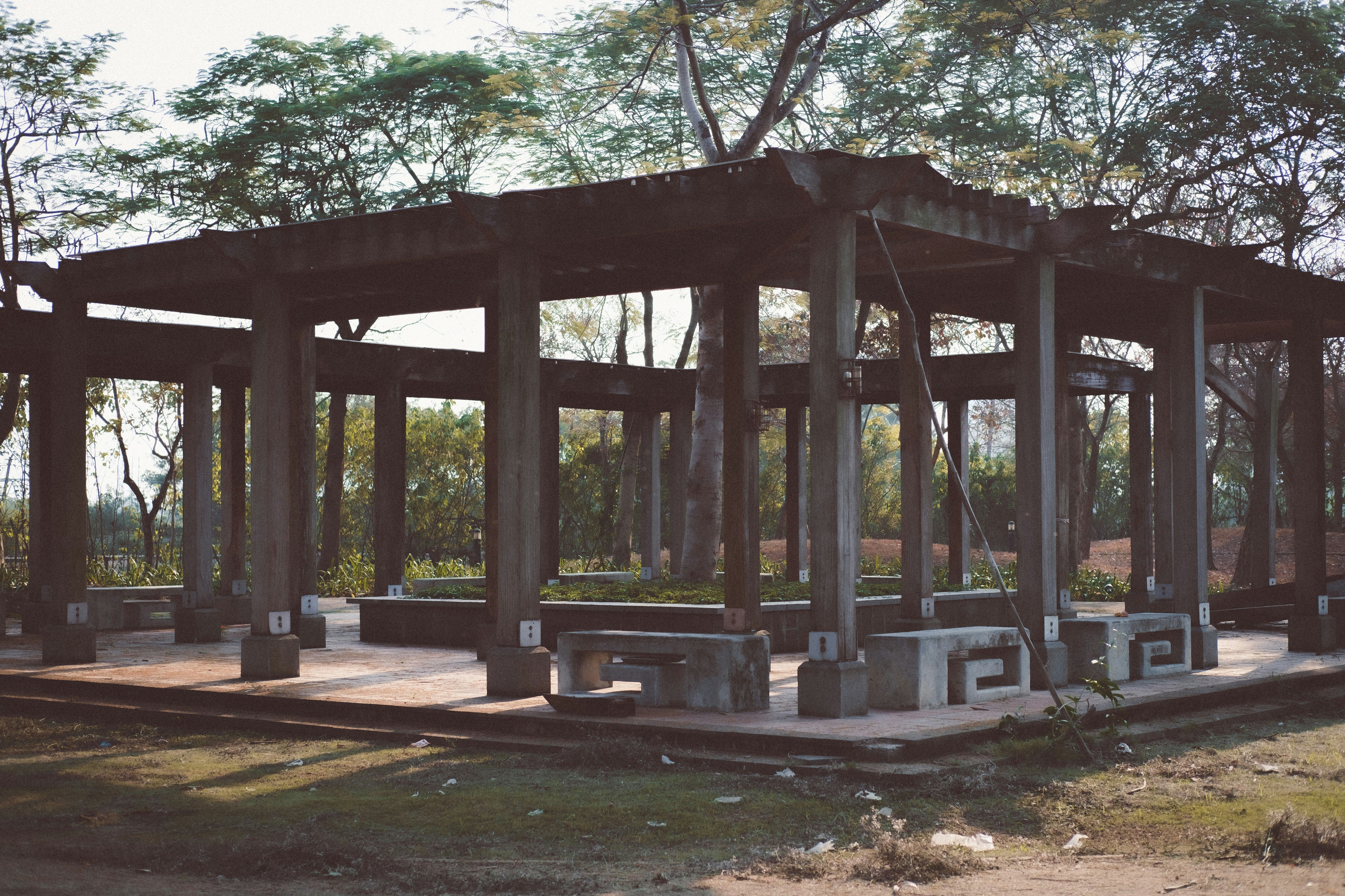 a wooden structure sitting in the middle of a park