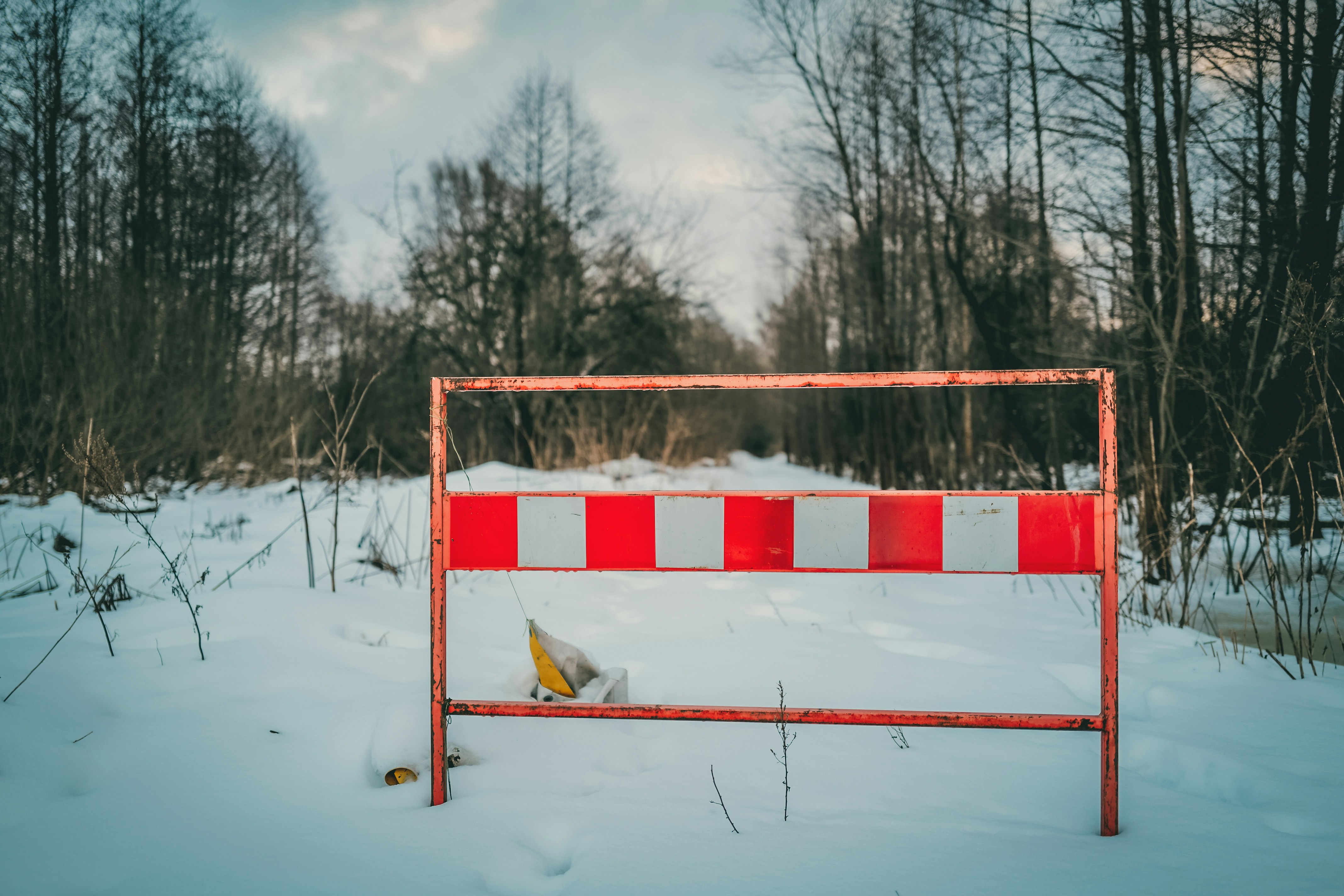 A red and white barricade sitting in the snow photo – Free Latvia Image ...