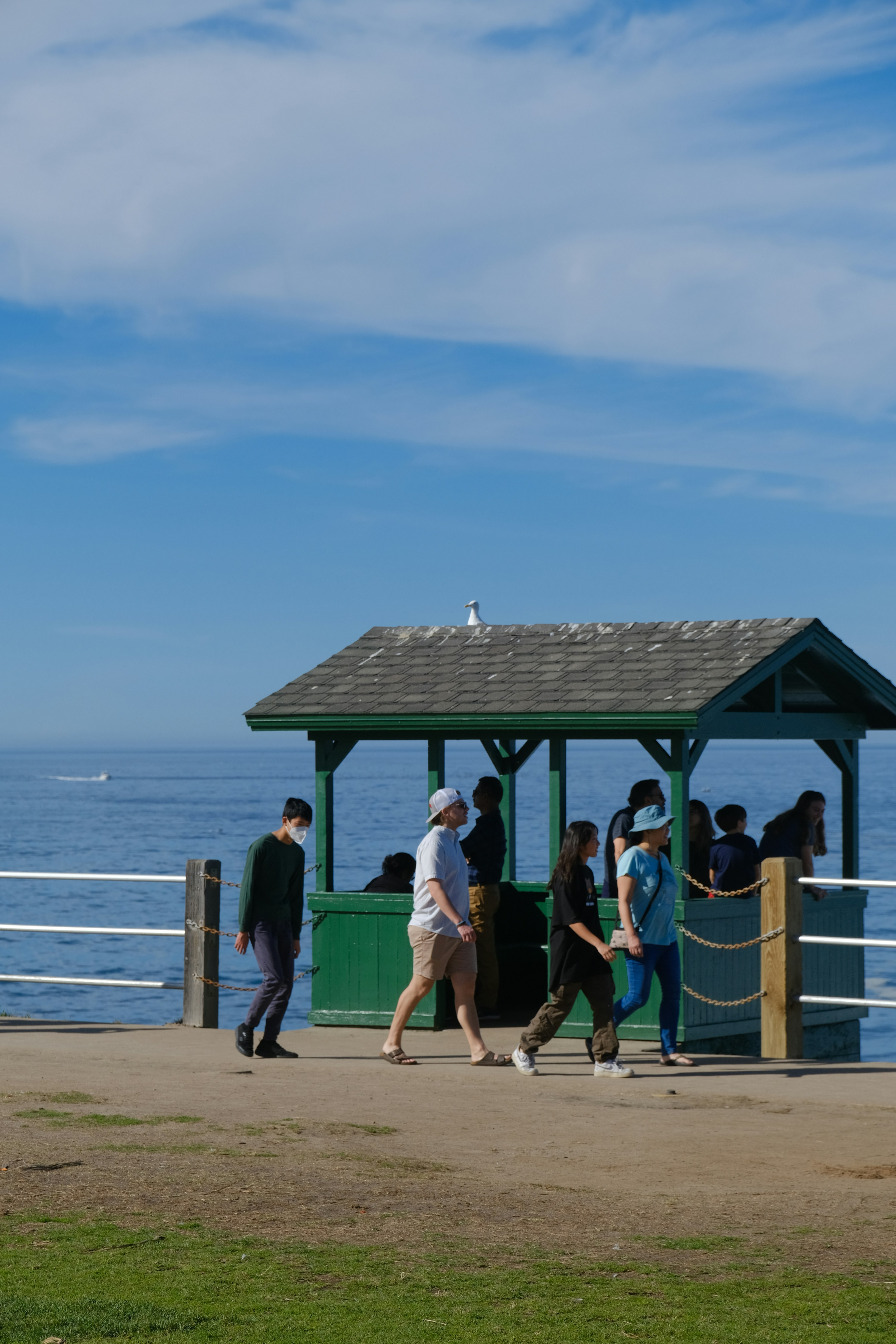 a group of people walking on a beach next to the ocean
