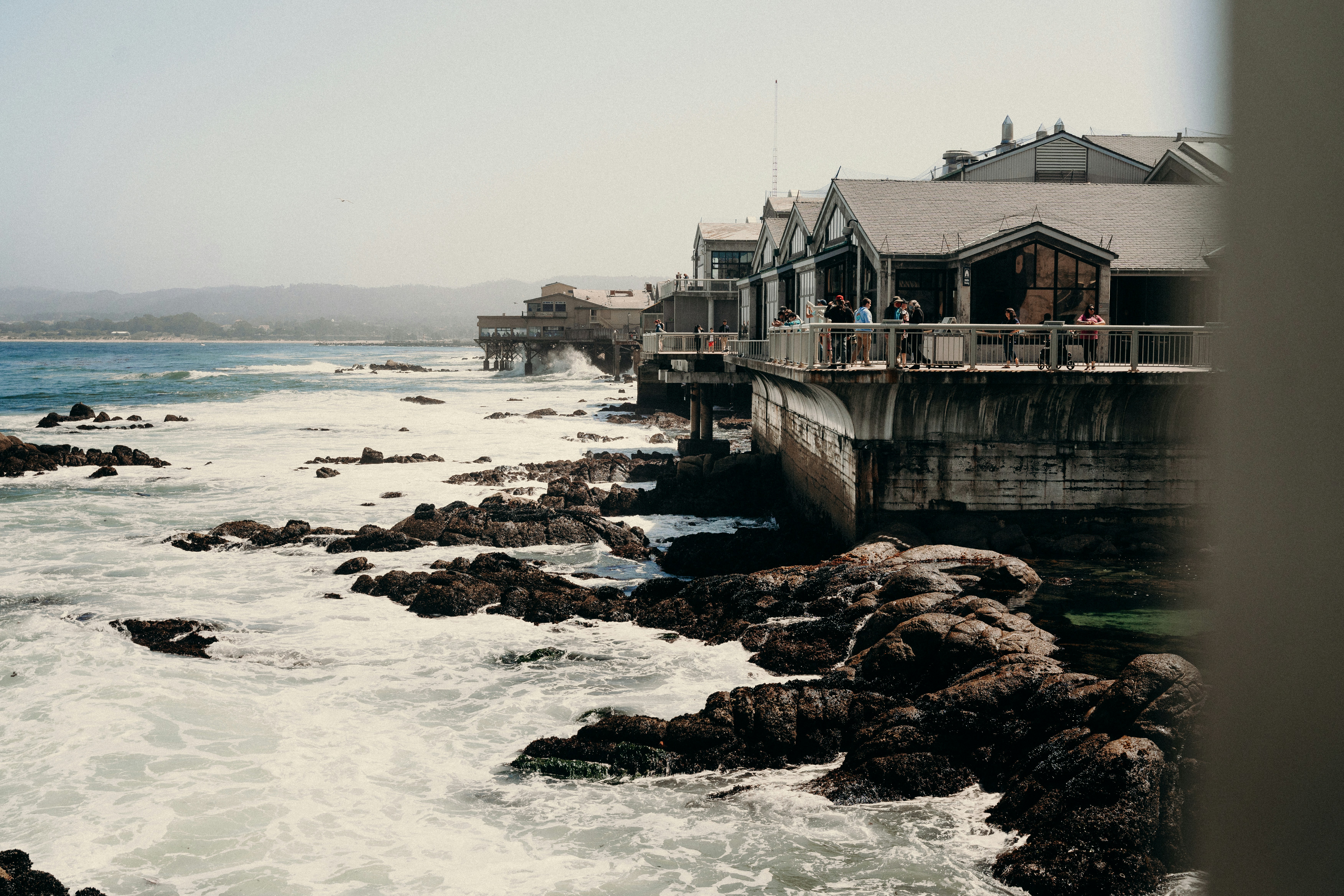 Coastal Boardwalk at Breaker Point: Weathered Pier Meets Roaring Sea