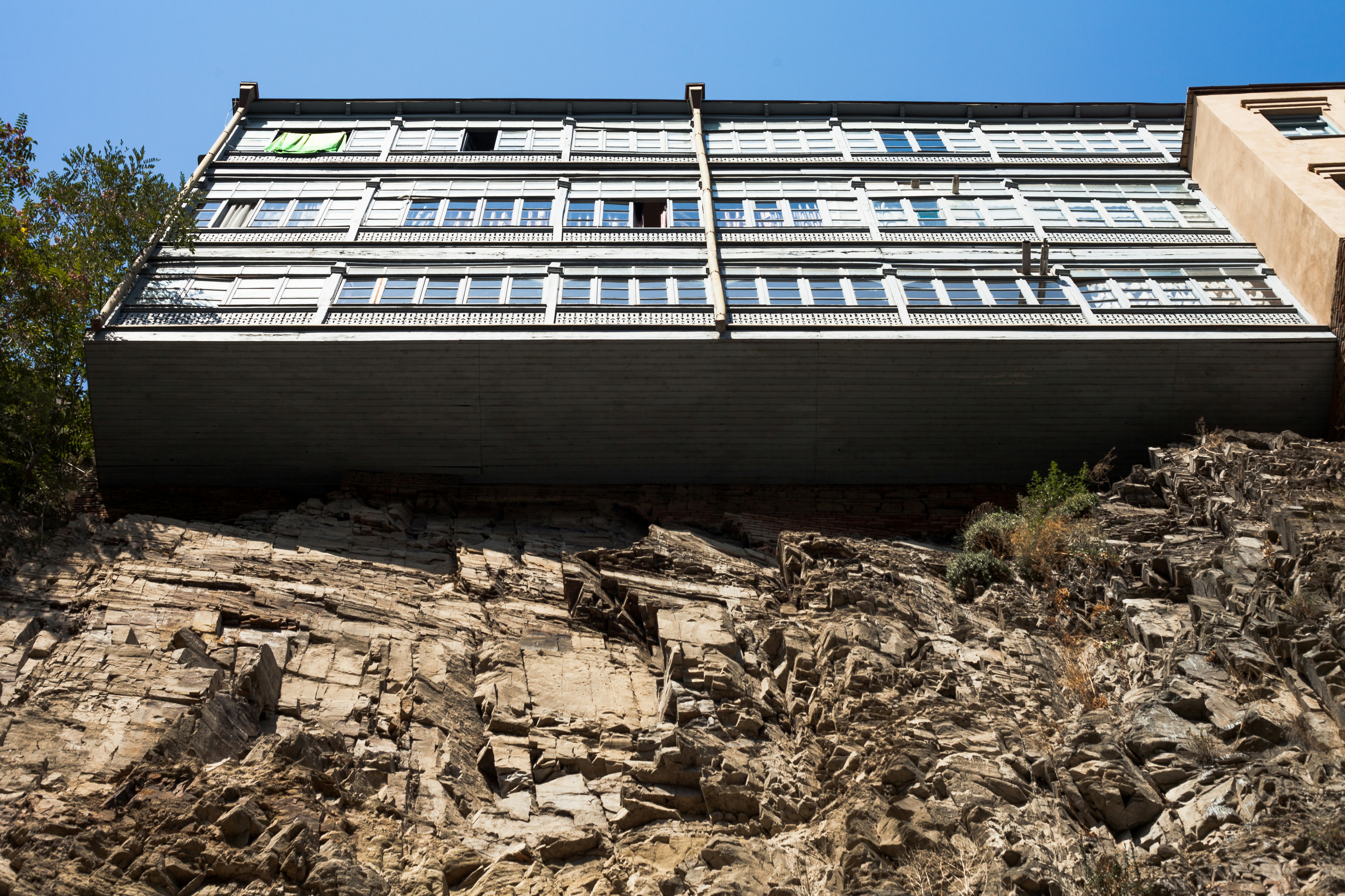 a very tall building sitting on the side of a cliff
