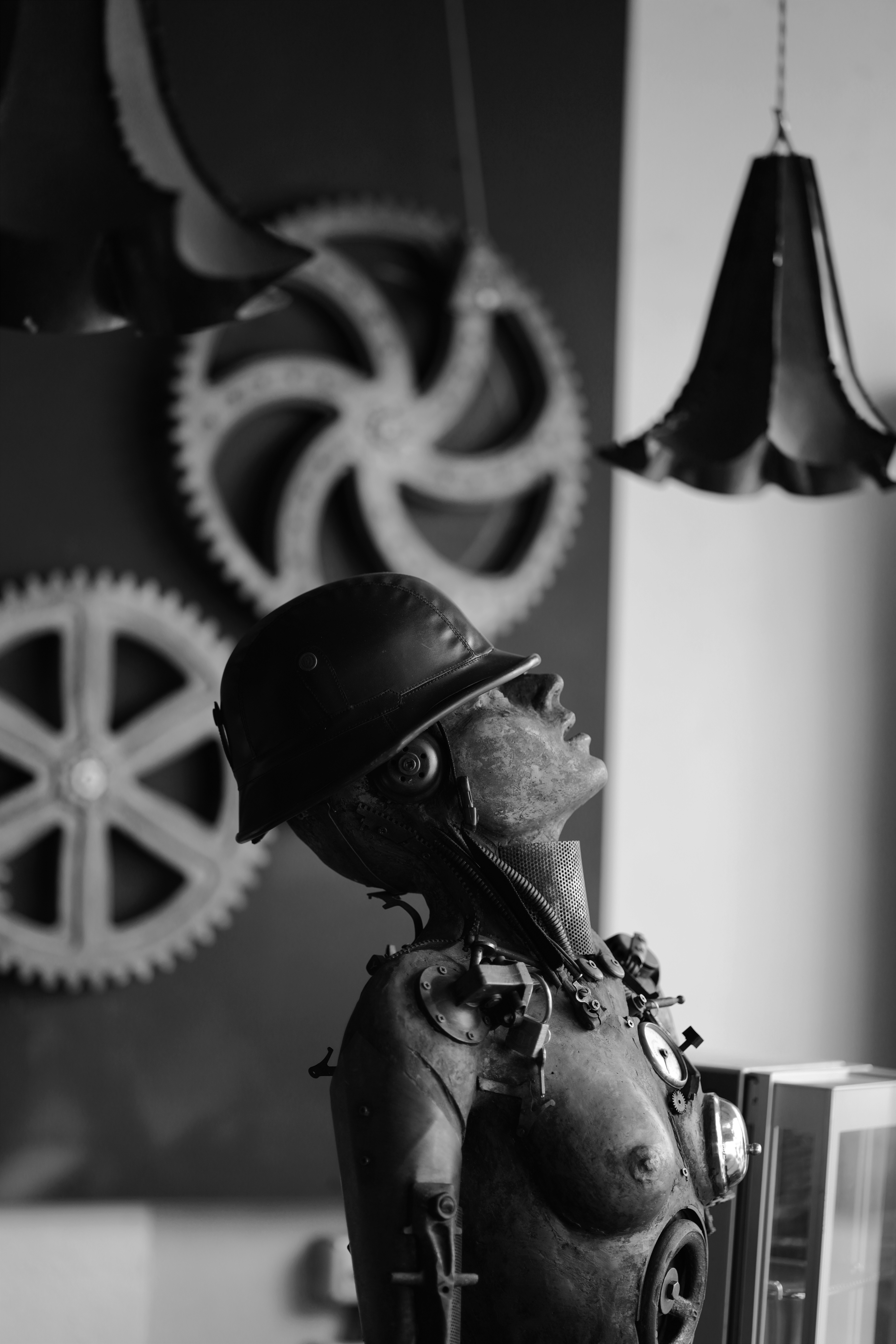 Industrial Marionette: A Rusted Soldier Beneath Looming Gears