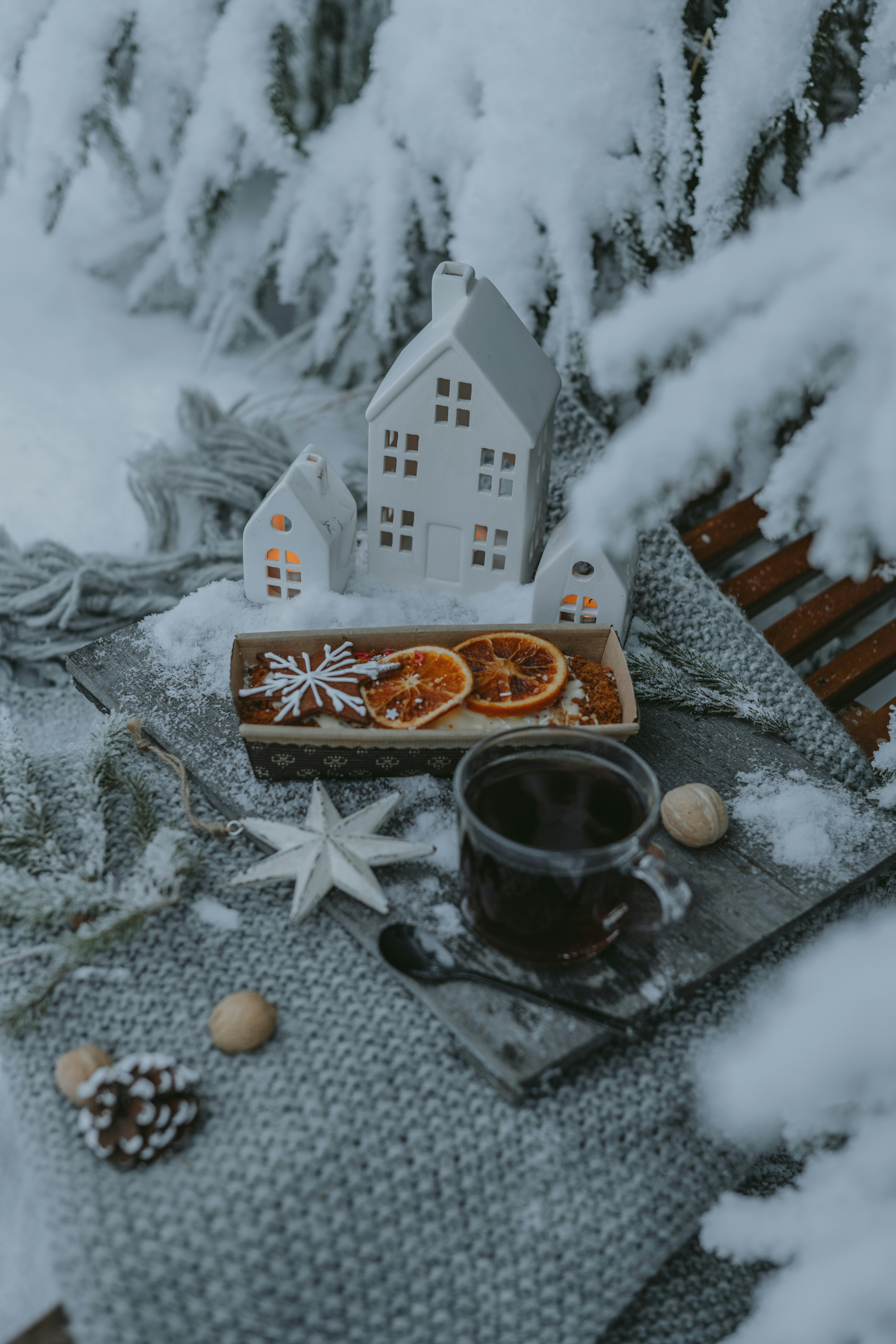 Winter Village Glow: Ceramic Houses Beside Dried Citrus and Tea