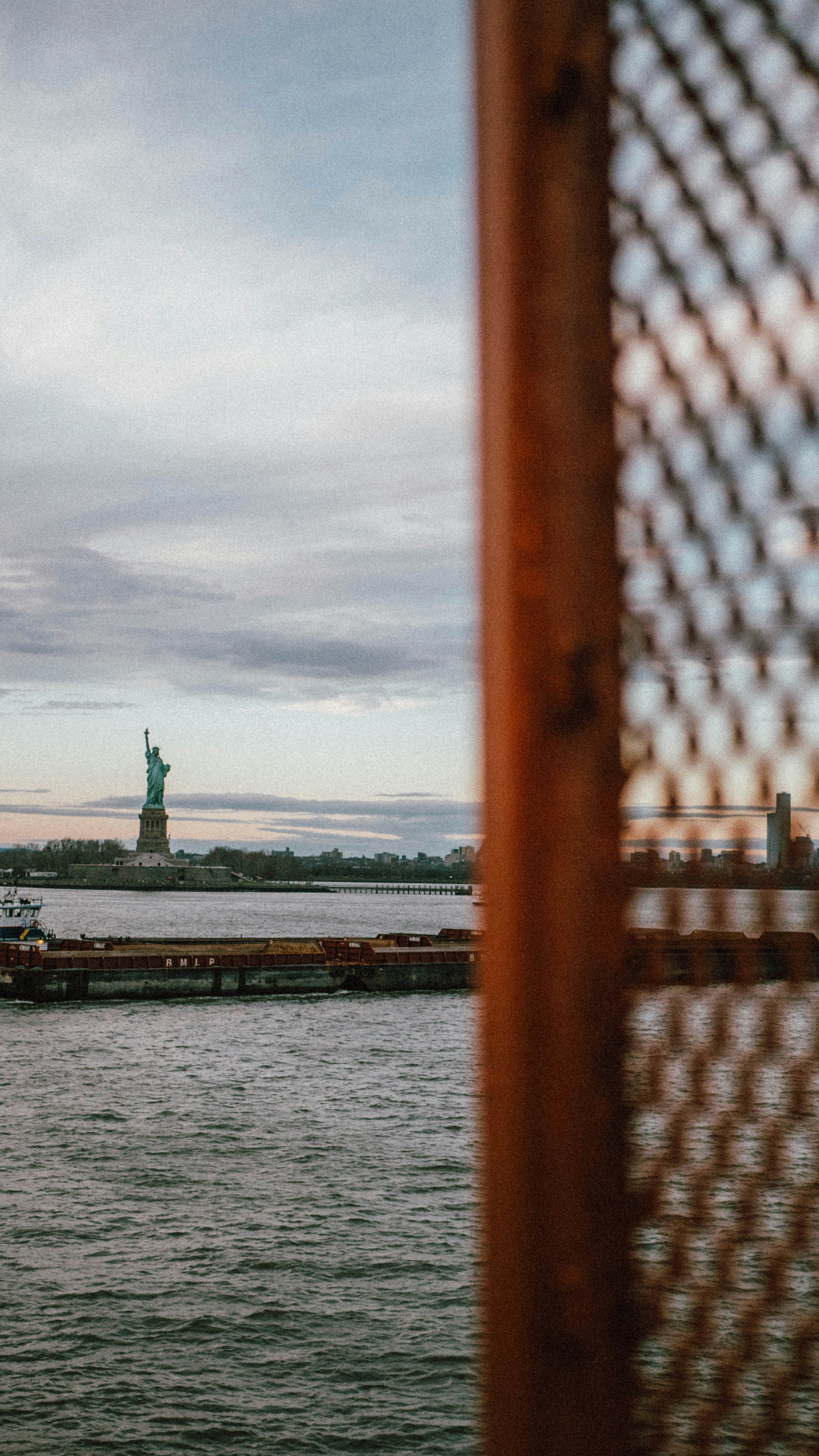 a view of the statue of liberty from across the water