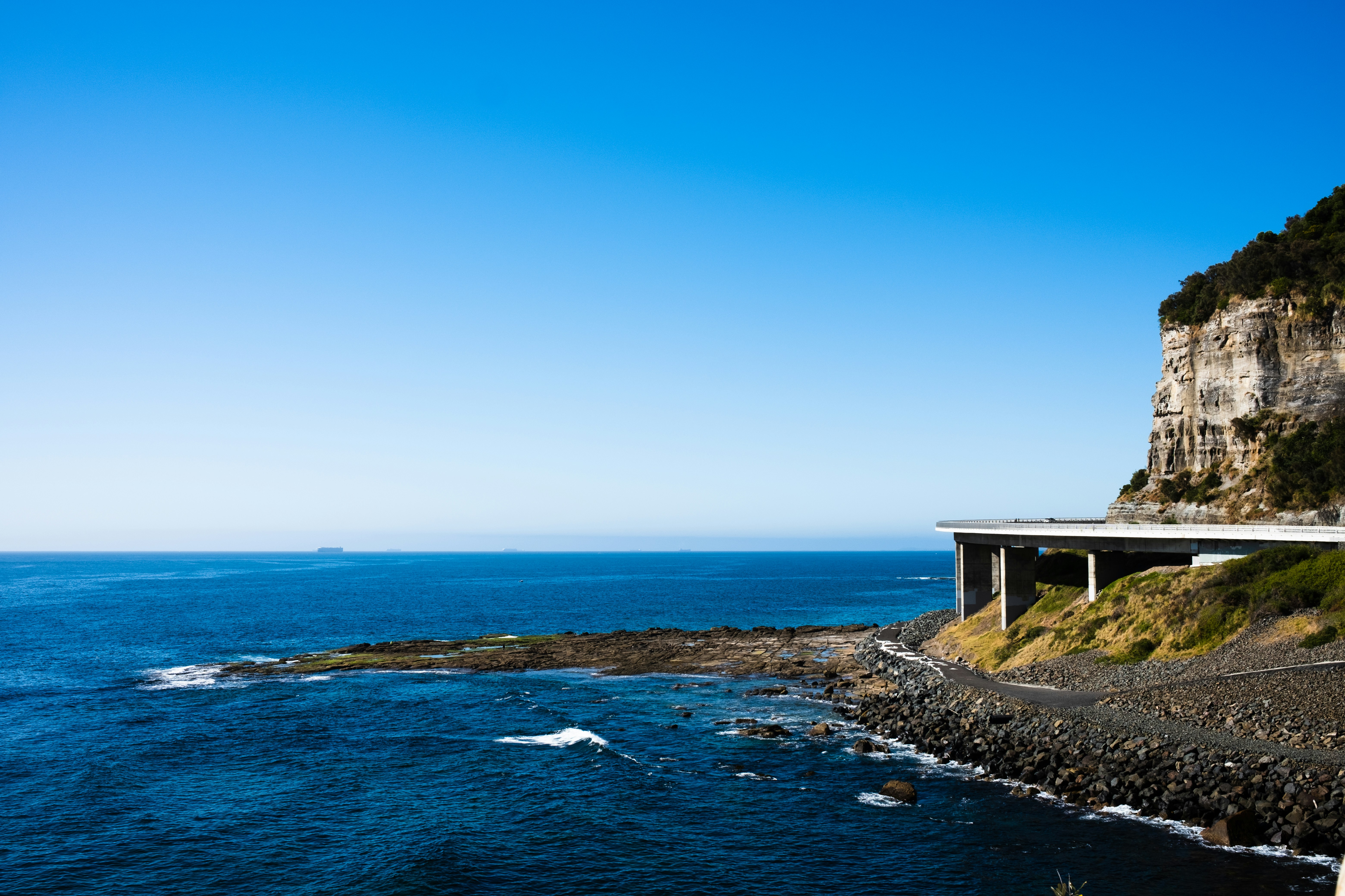 a scenic view of the ocean and a highway