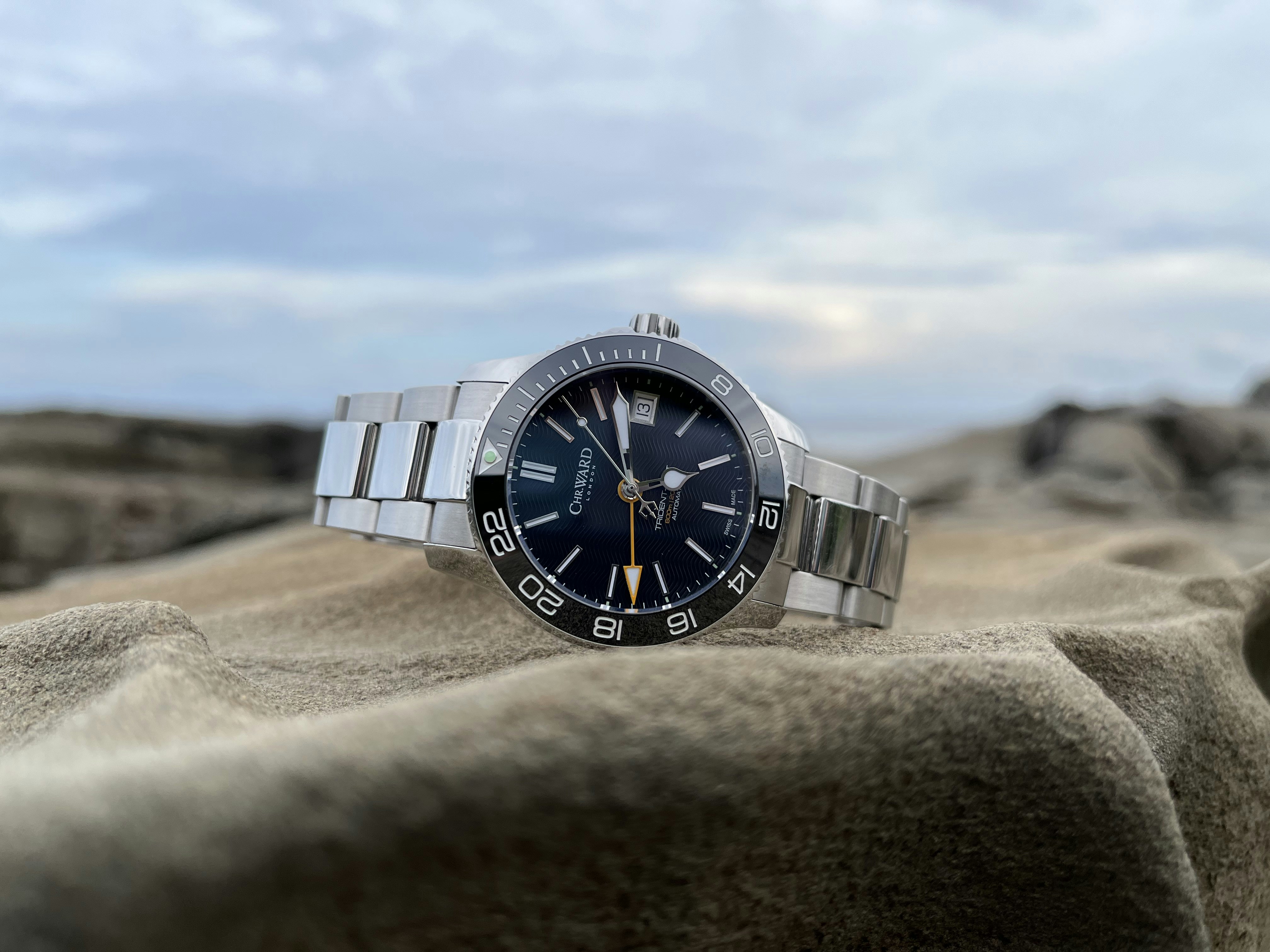 A watch sitting on top of a beach covered in sand photo – Free ...
