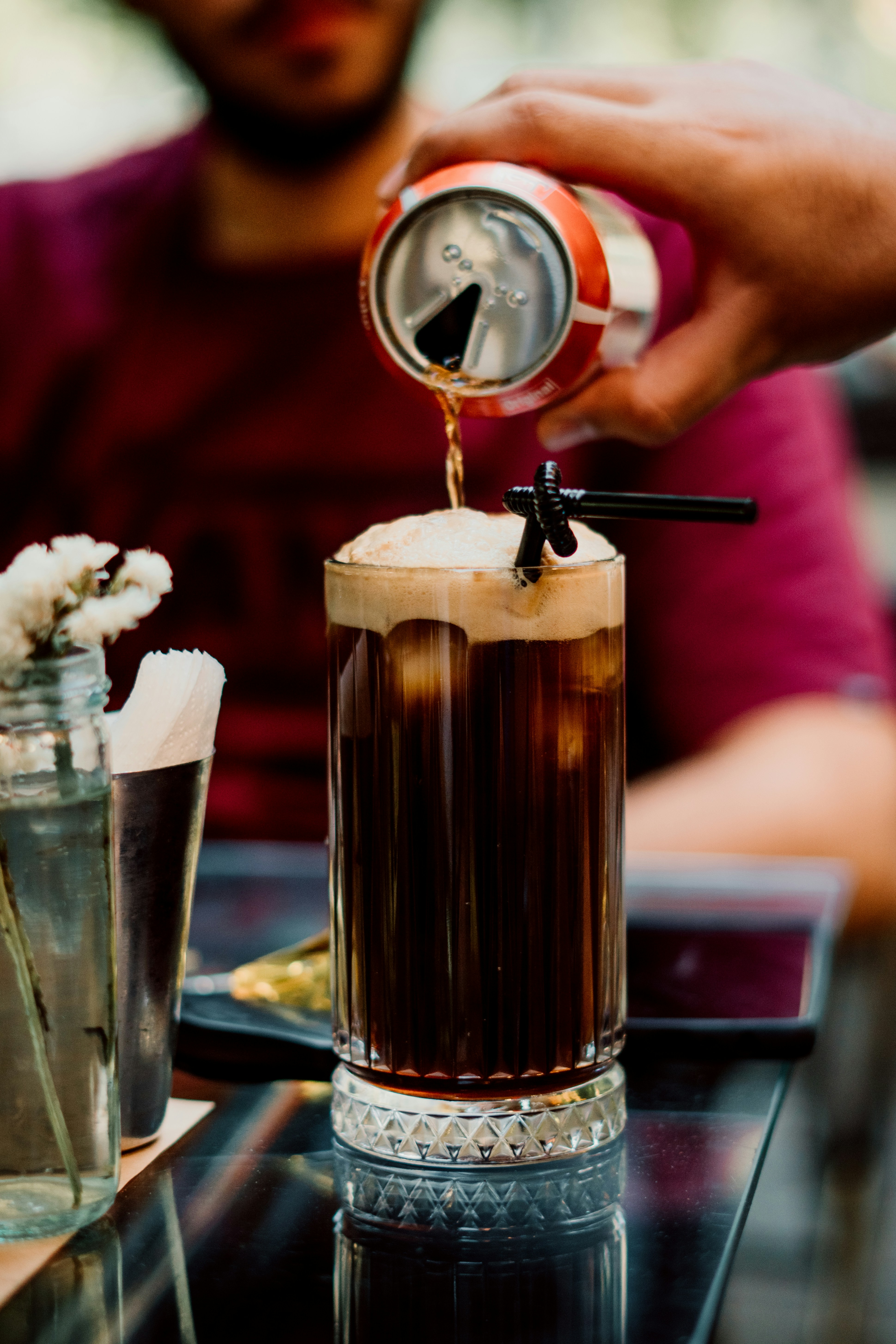 A person pouring something into a tall glass photo – Free Cup Image on ...
