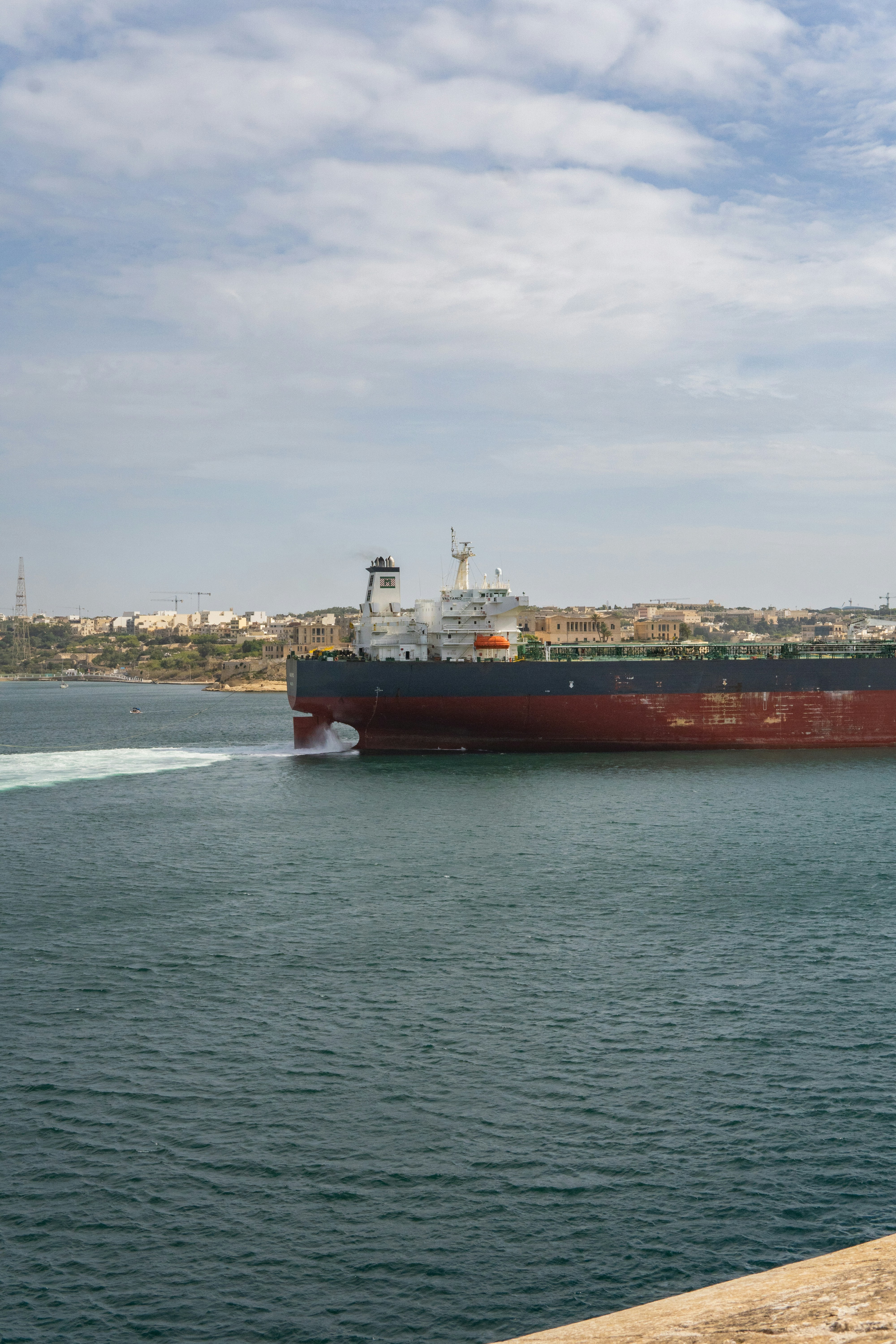 A Coastline Carrier: A Freight Ship Skims the Harbor