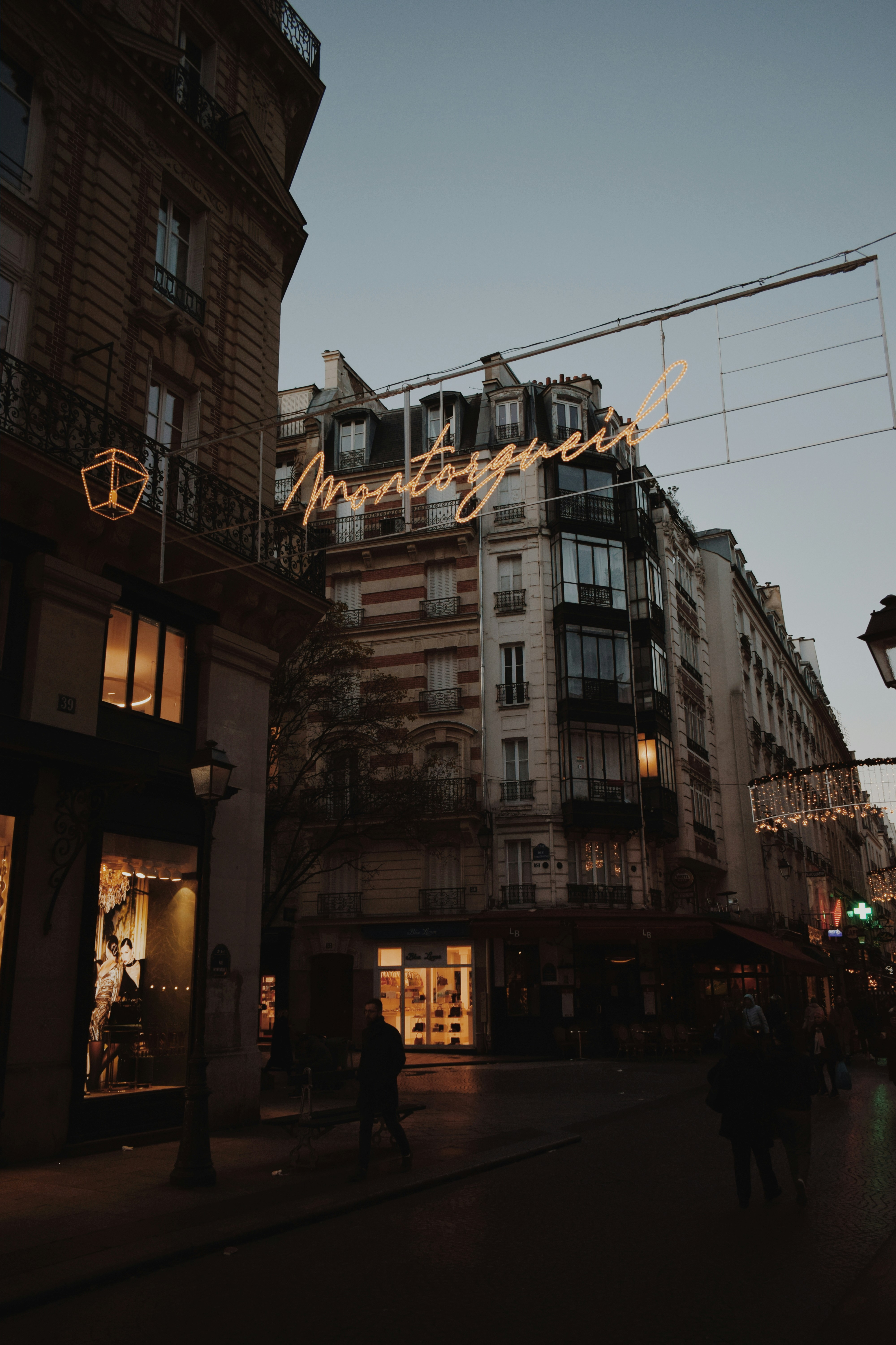 Neon Script Draped Across a Dim European Street at Twilight