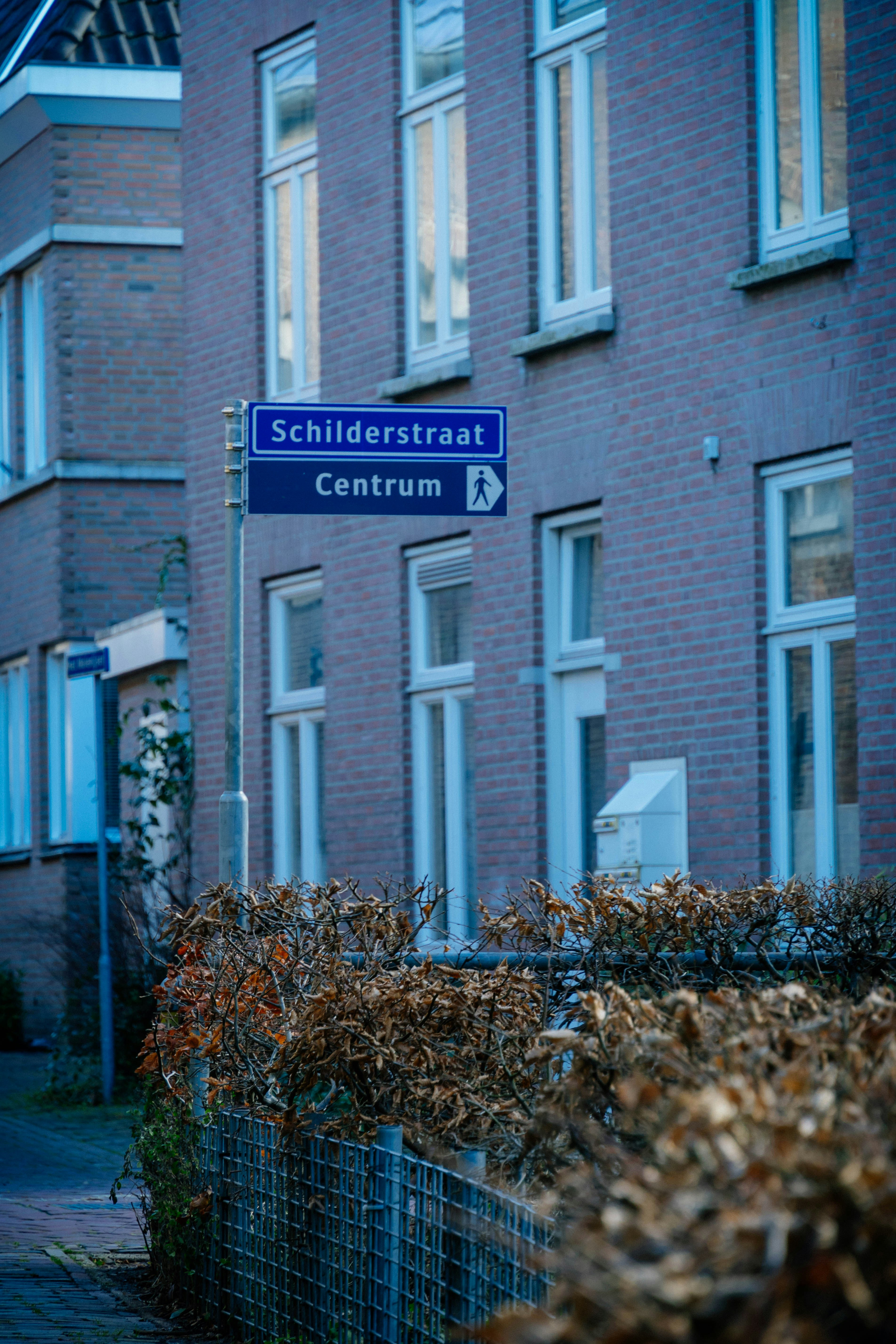 a street sign in front of a brick building