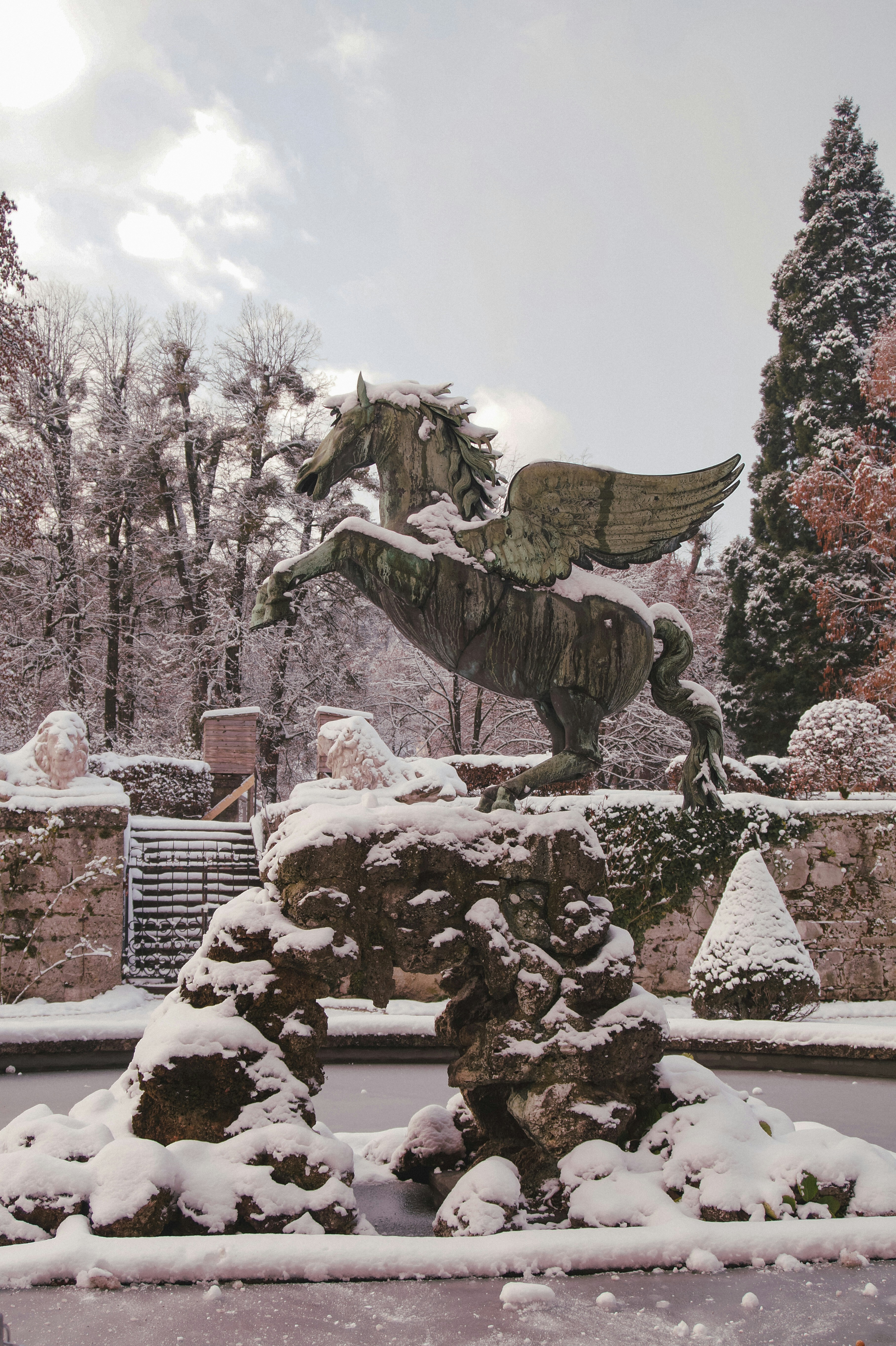 Pegasus in Frost: Winged Sculpture in a Snow-Kissed Garden