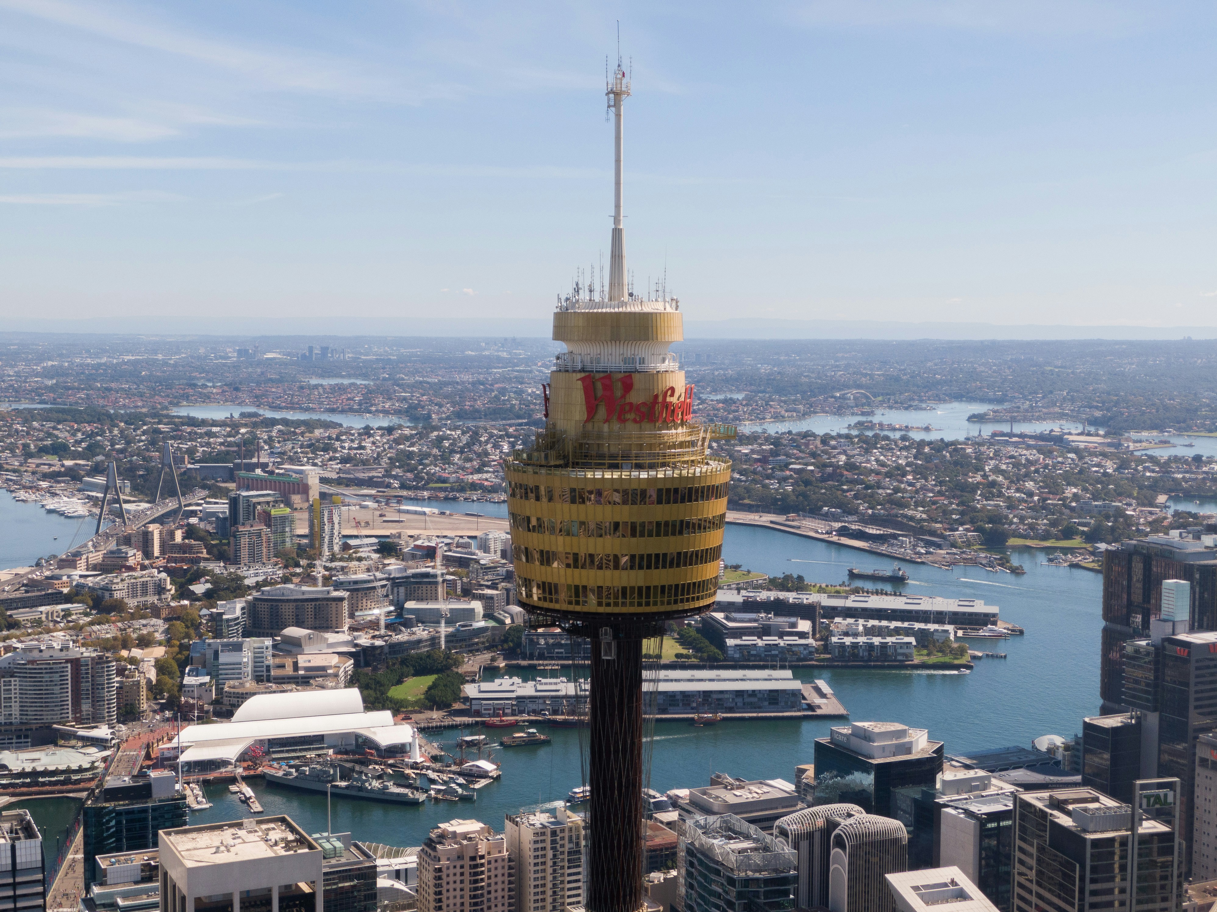 Harbor Crown: Aerial Portrait of a Towering City with a Golden Observation Pod