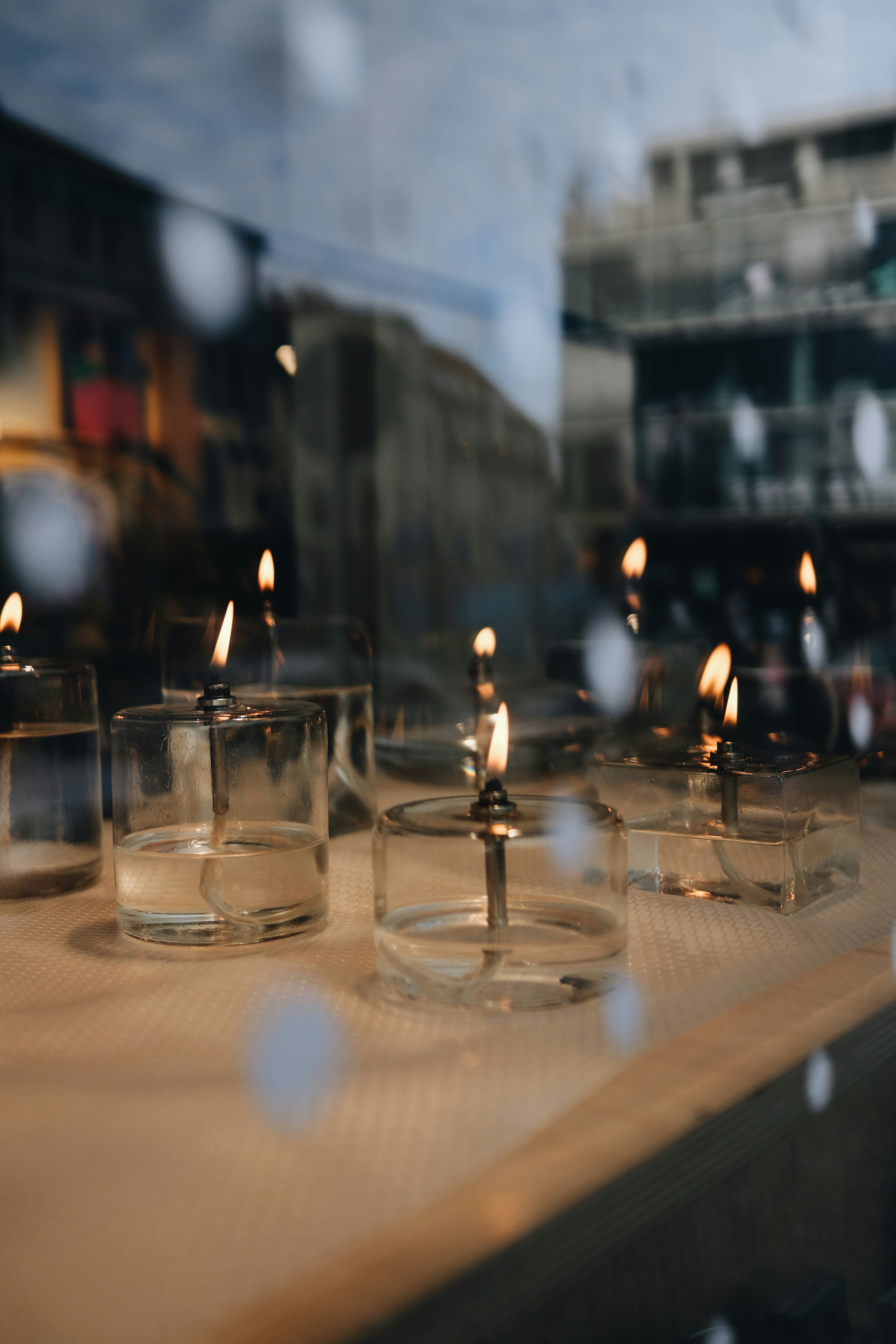 Candlelit Still Life: Warm Flames Behind a Glass Window