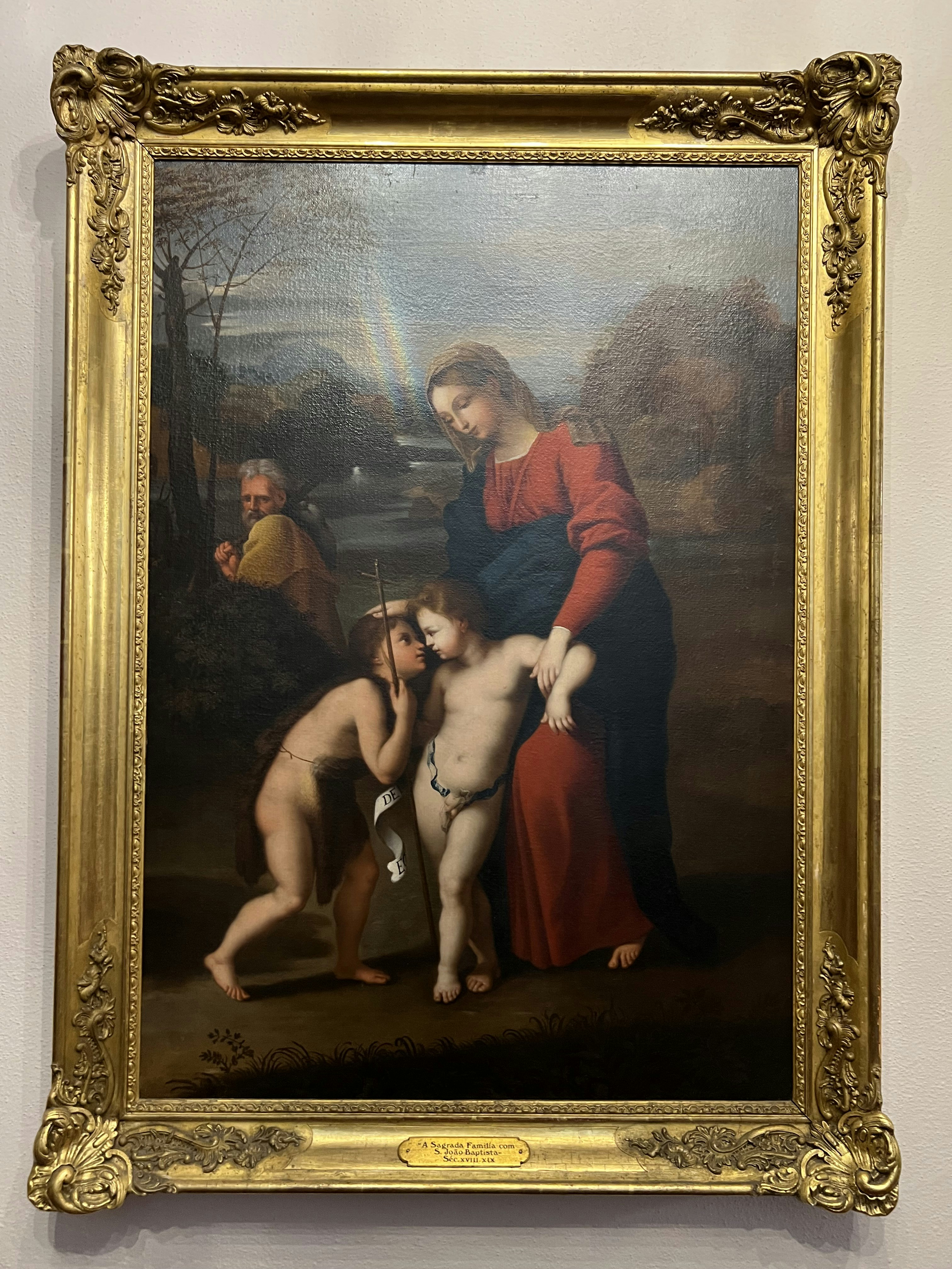 Riverside Madonna with Two Children Beneath a Gentle Rainbow
