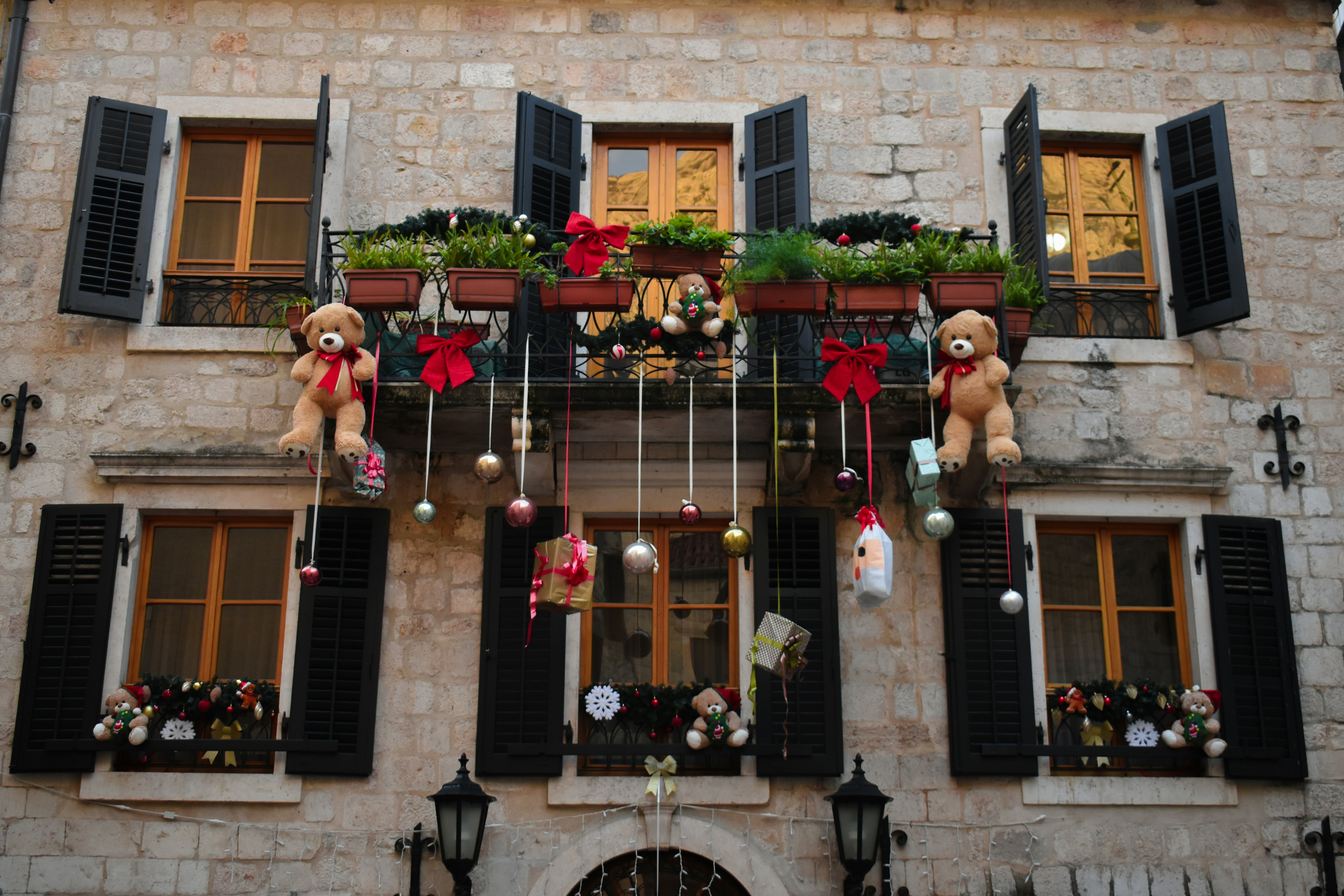 Teddy Parade Over a Stone Townhouse Balcony
