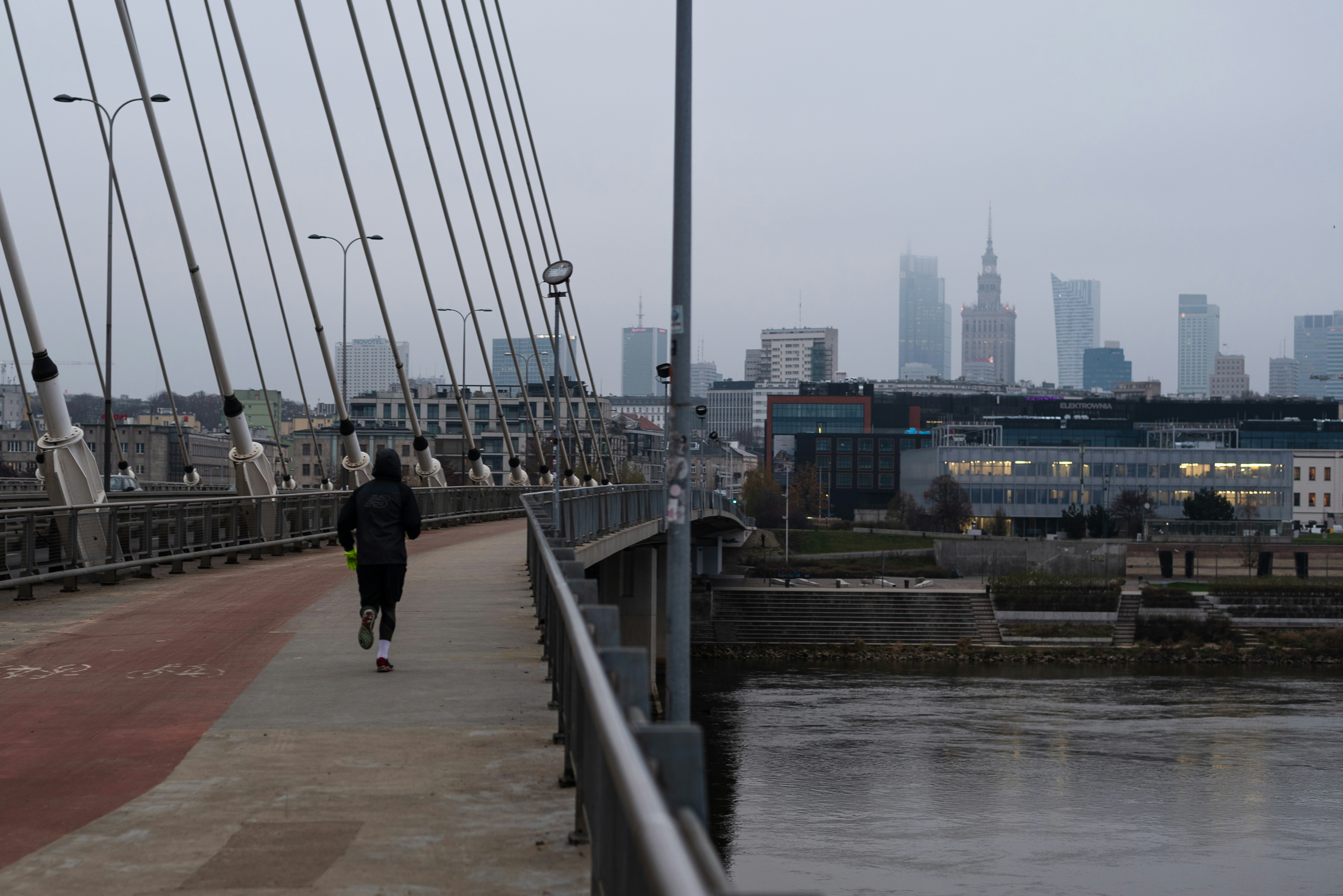 a person walking across a bridge over a river