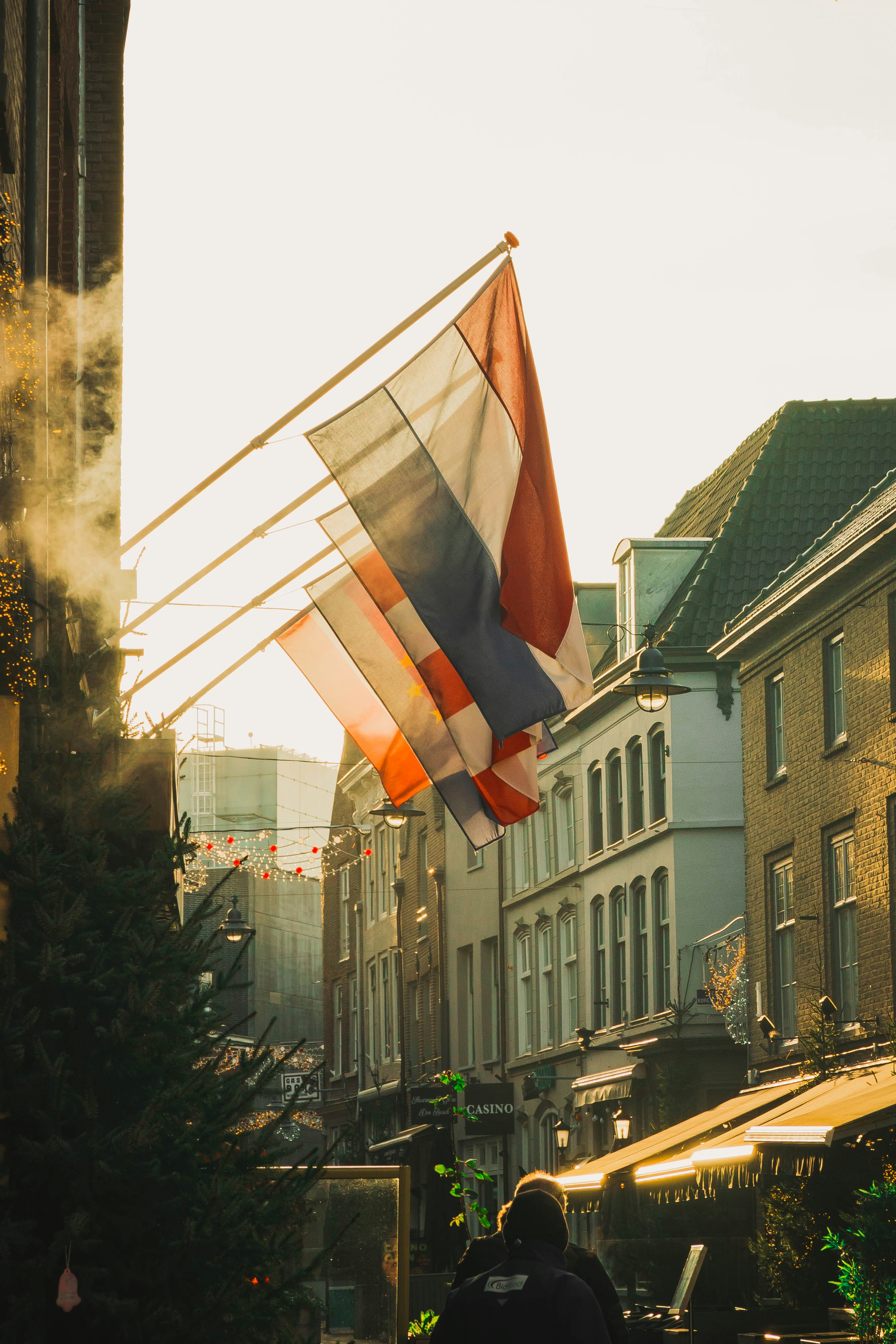 Flags over a sunlit downtown street