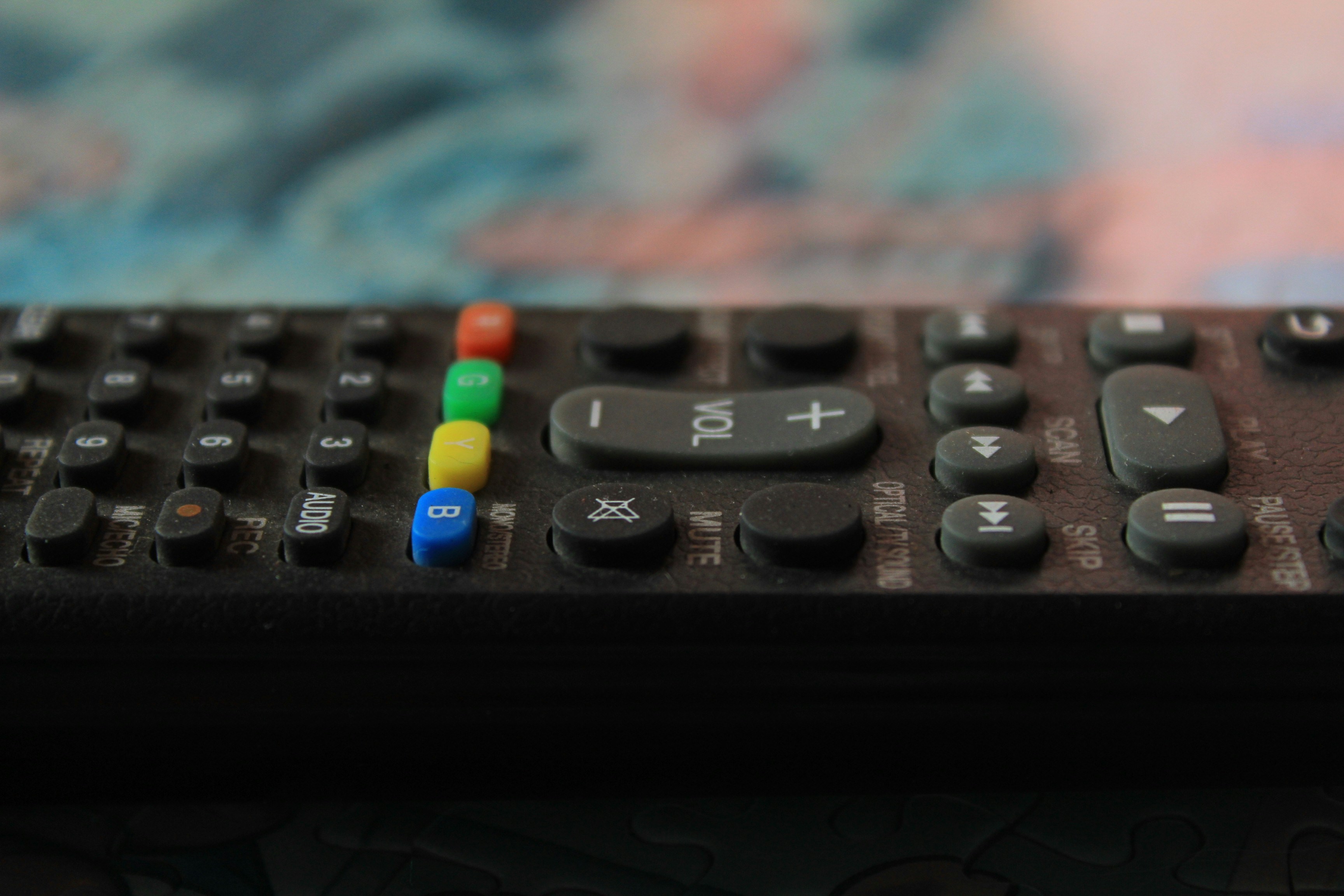 A close up of a remote control on a table photo – Free Electronics ...