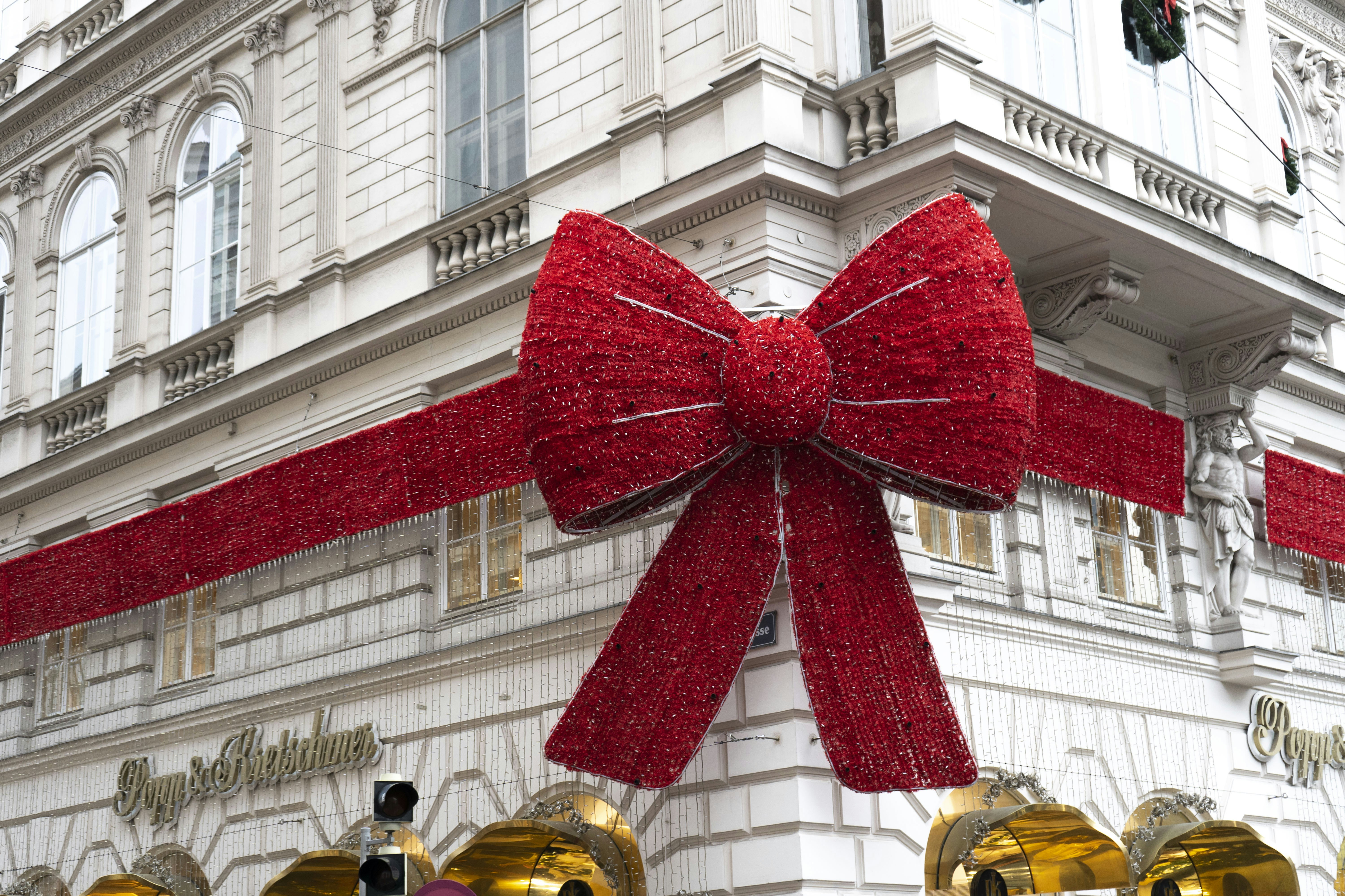A large red bow hanging from the side of a building photo – Free Vienna ...