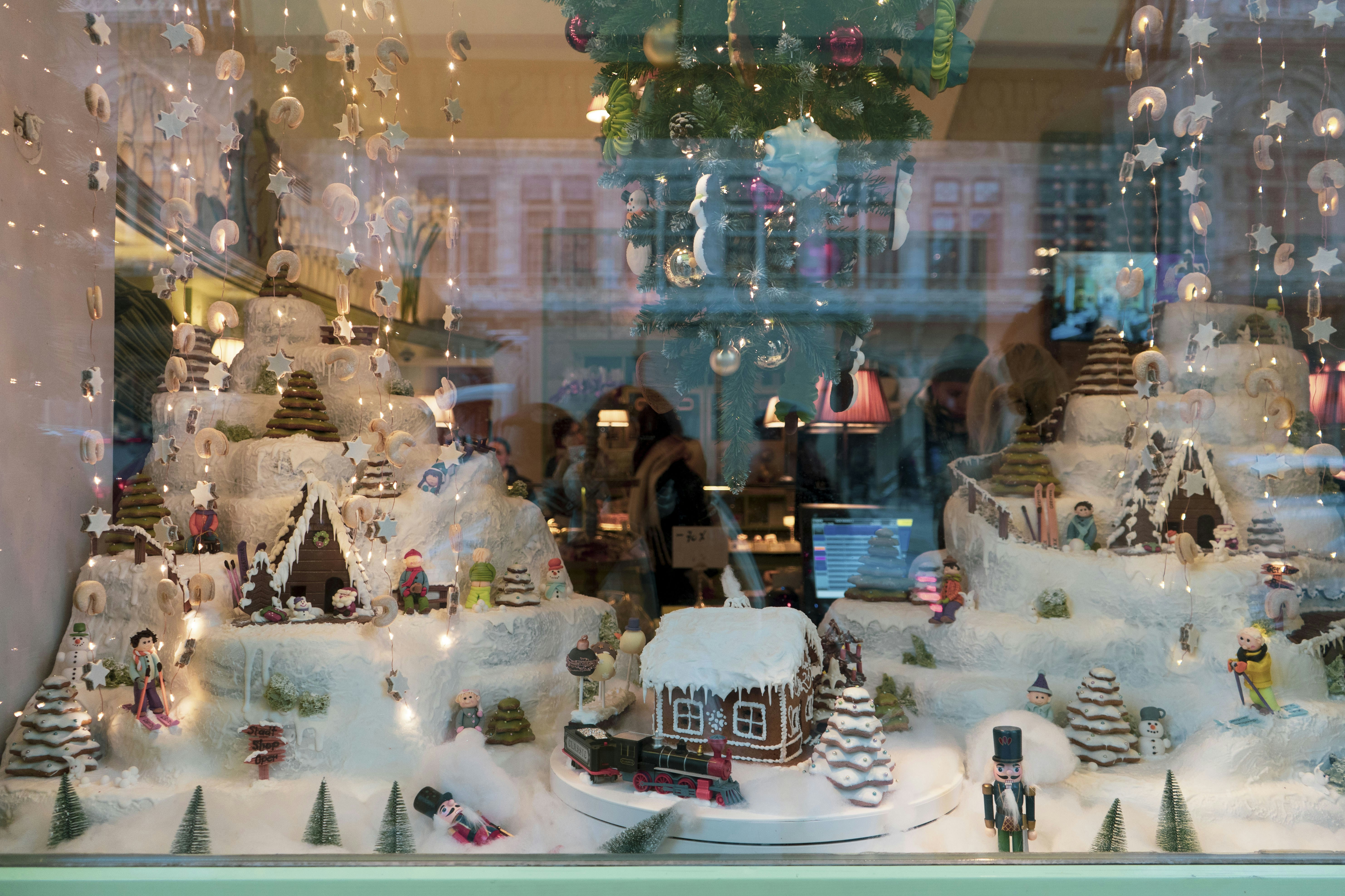 A window display of a christmas village in a store photo – Free ...