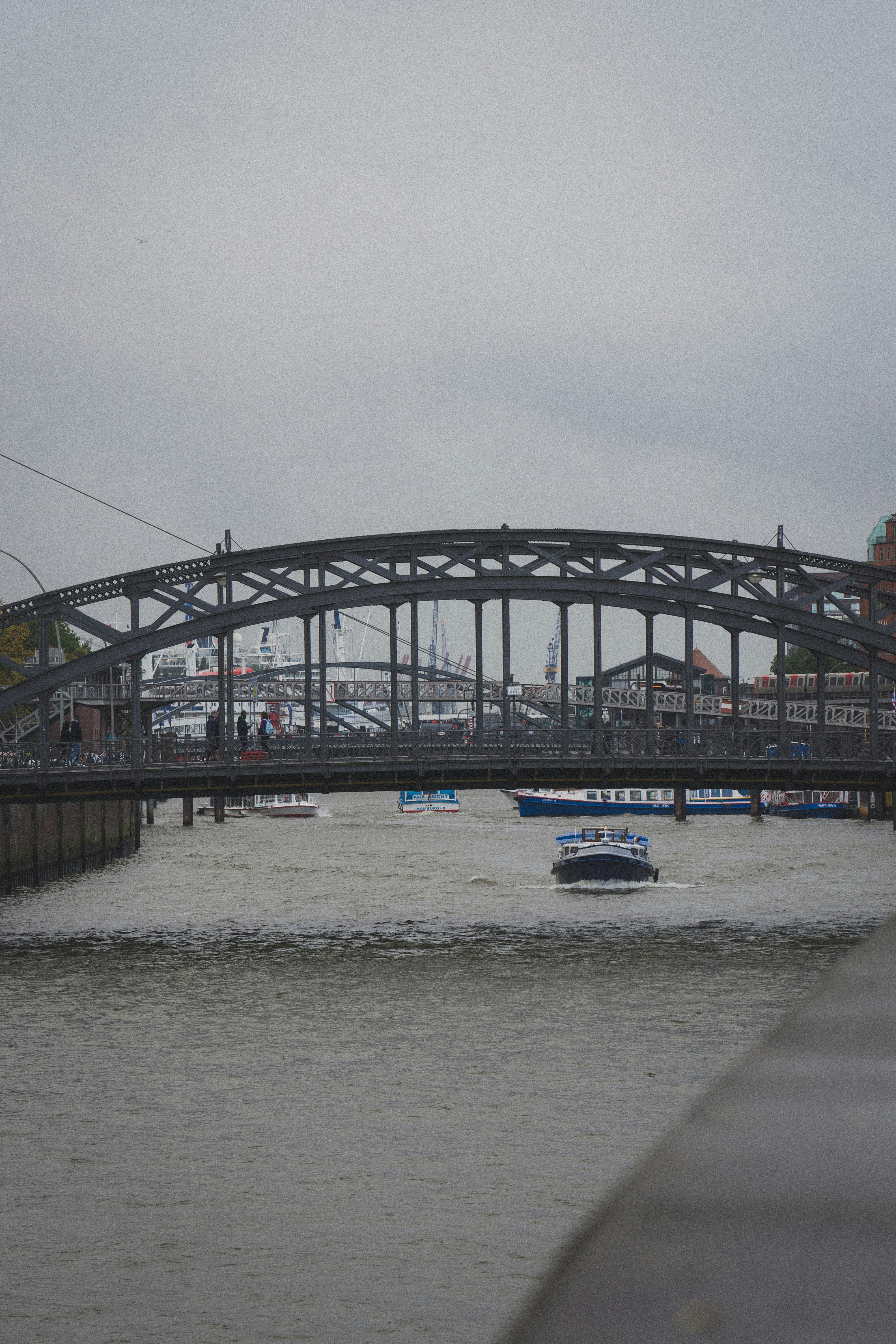 A bridge over a body of water with boats on it photo – Free Allemagne ...