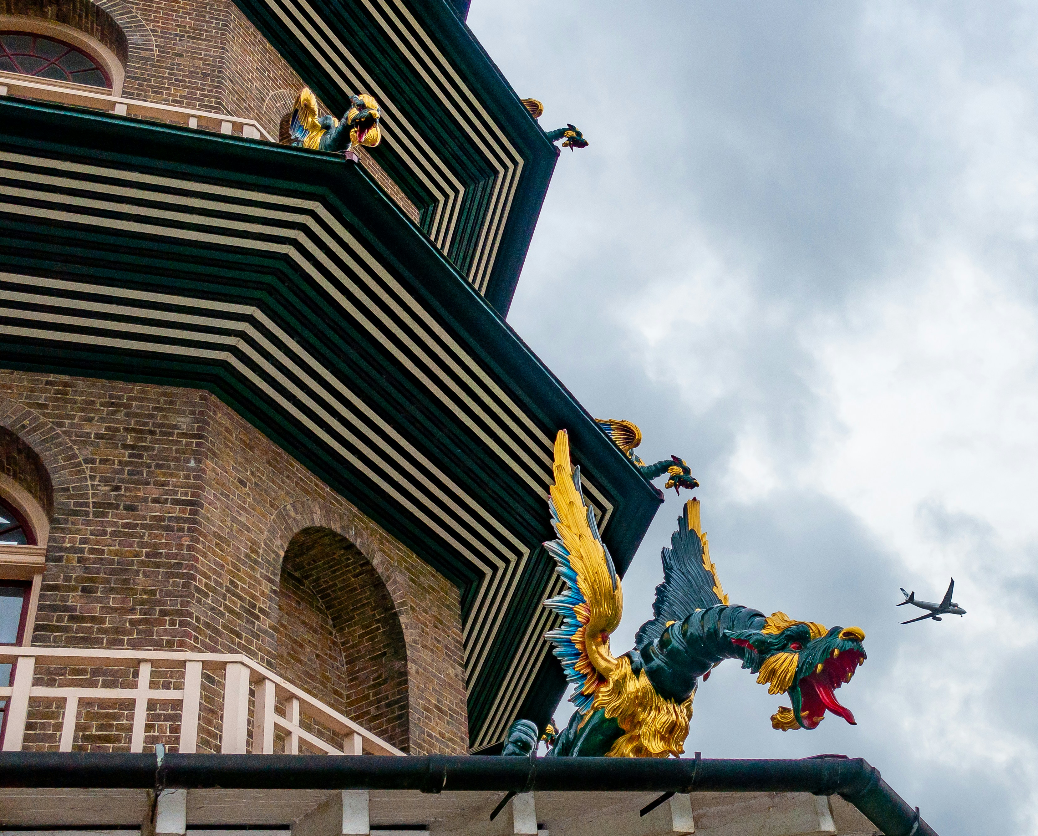 A statue of a dragon on top of a building photo – Free Dragon Image on ...