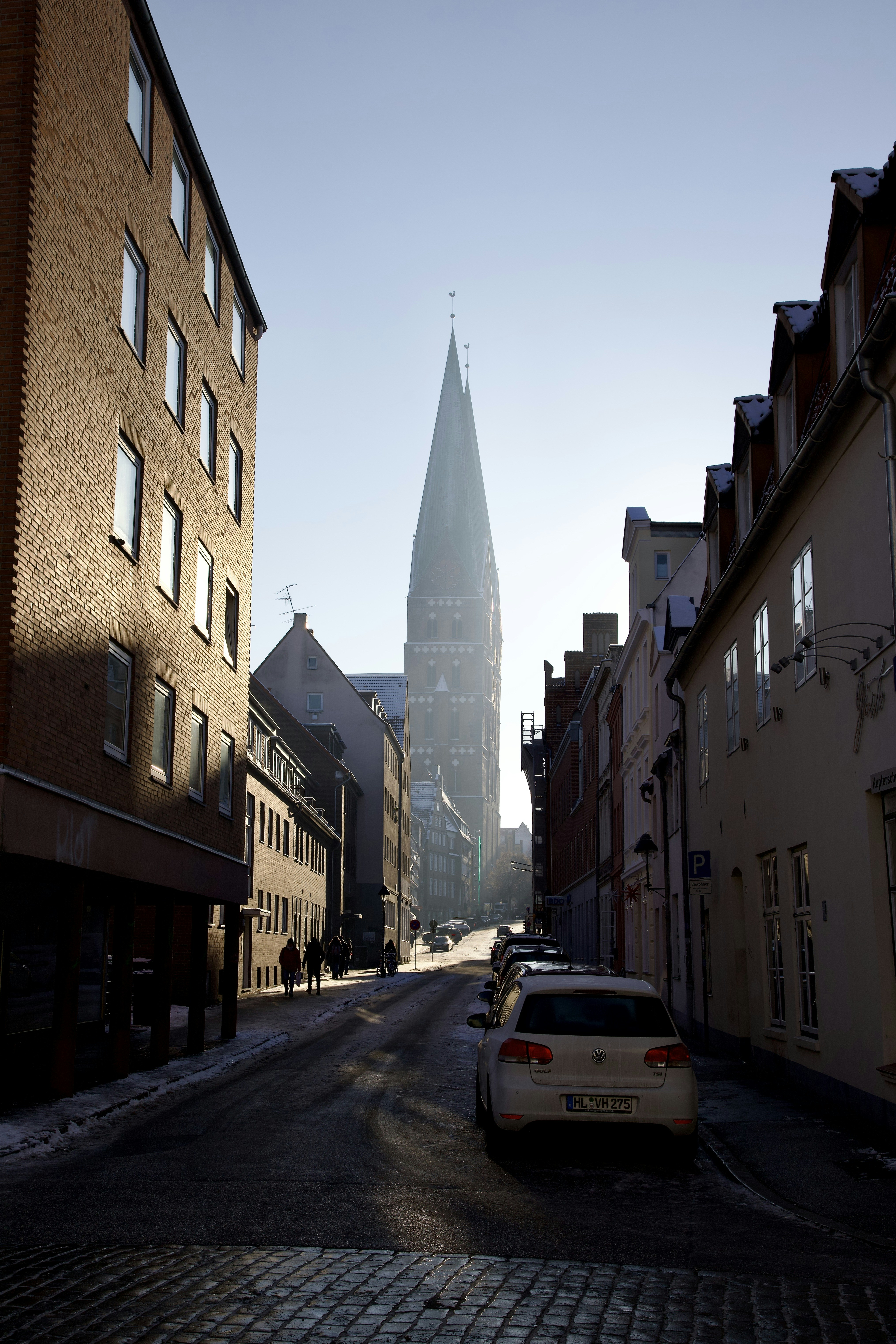 Dawn Framing a Snowlit Street Toward a Gothic Spire
