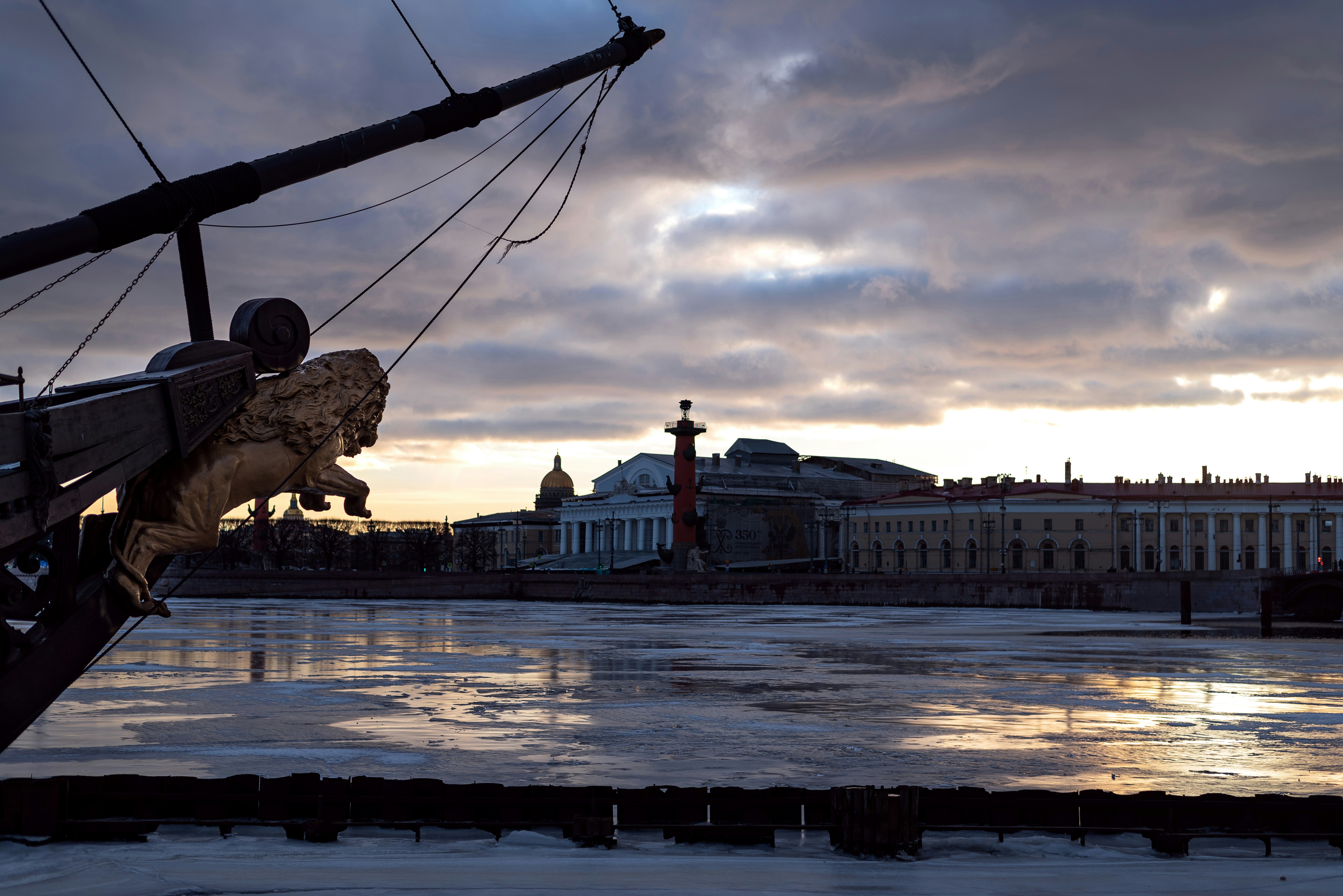 Rural Horizon over a Winter Harbor: The Bow and City Across the Ice