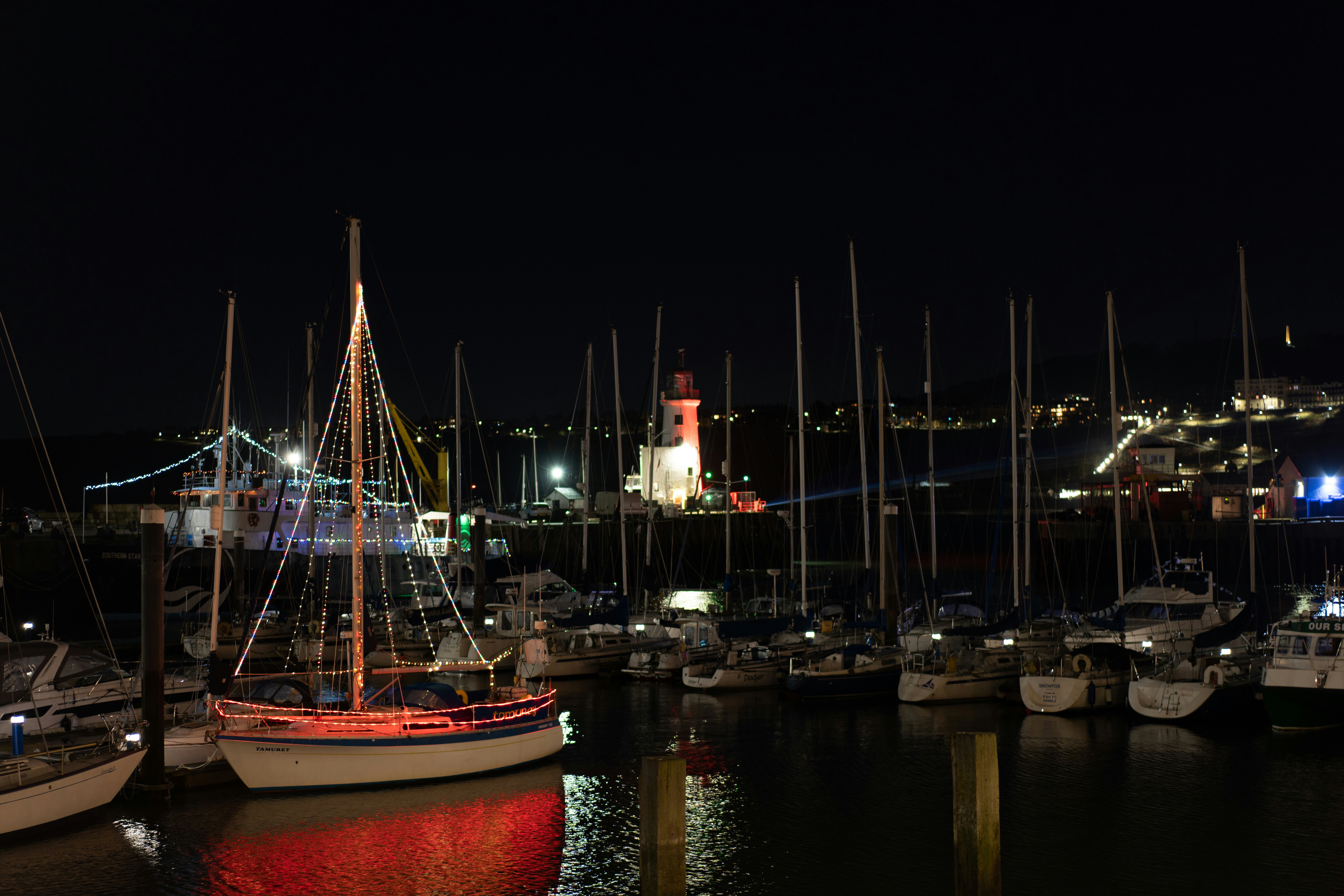 A harbor filled with lots of boats at night photo – Free Scarborough ...
