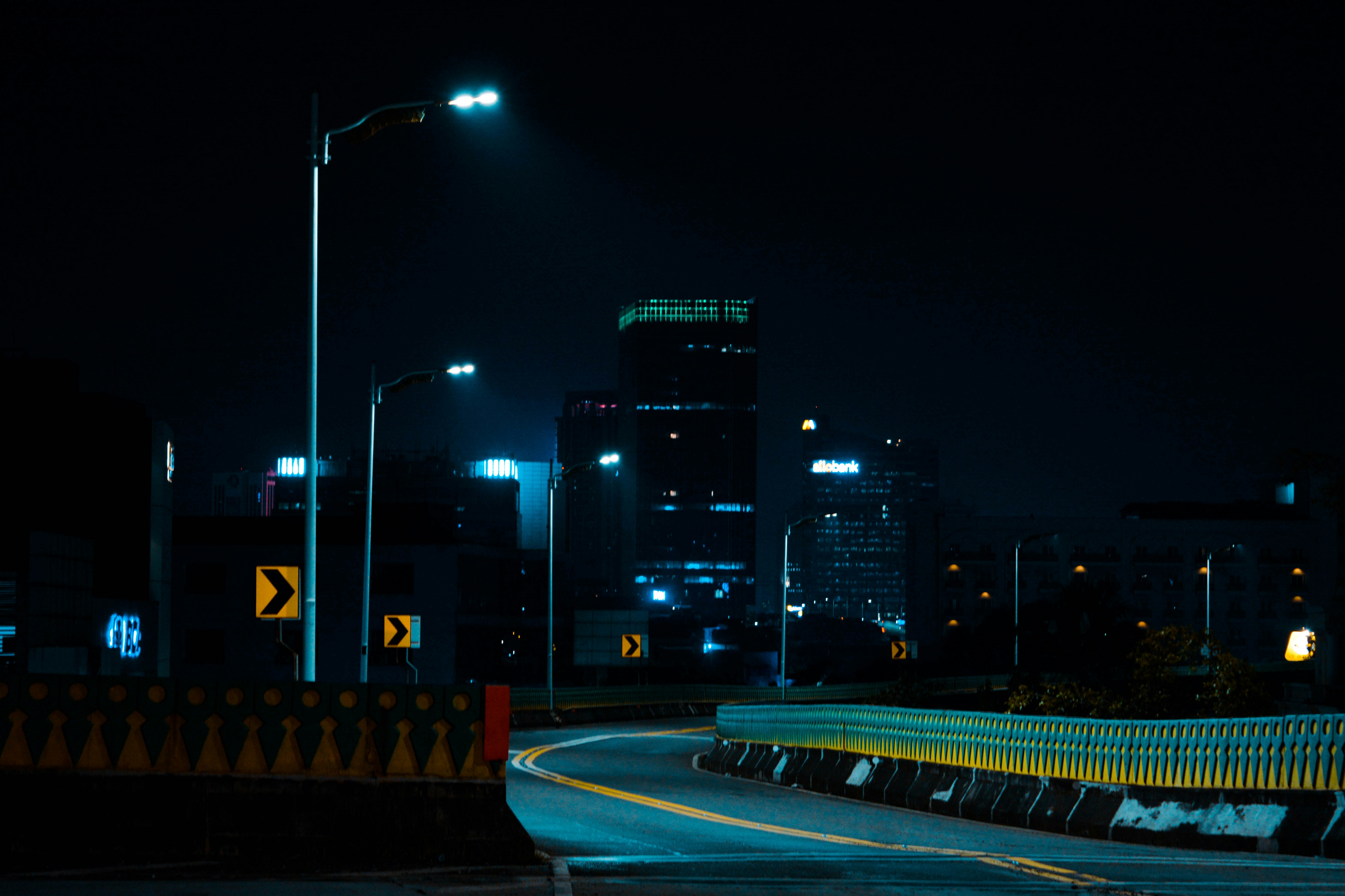 A city street at night with street lights photo – Free Indonesia Image ...