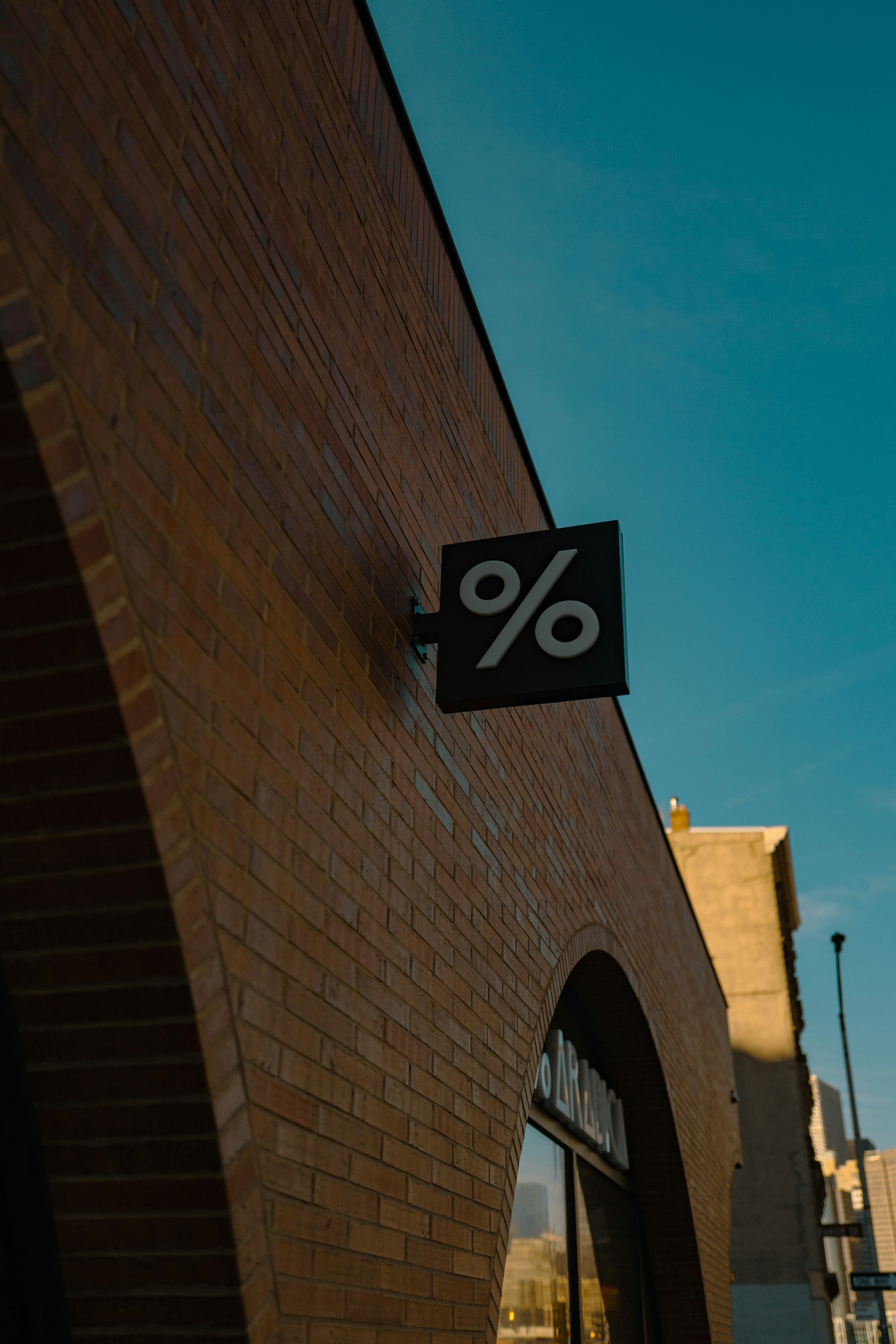Percent Sign on Brick Arch: Quiet Urban Geometry