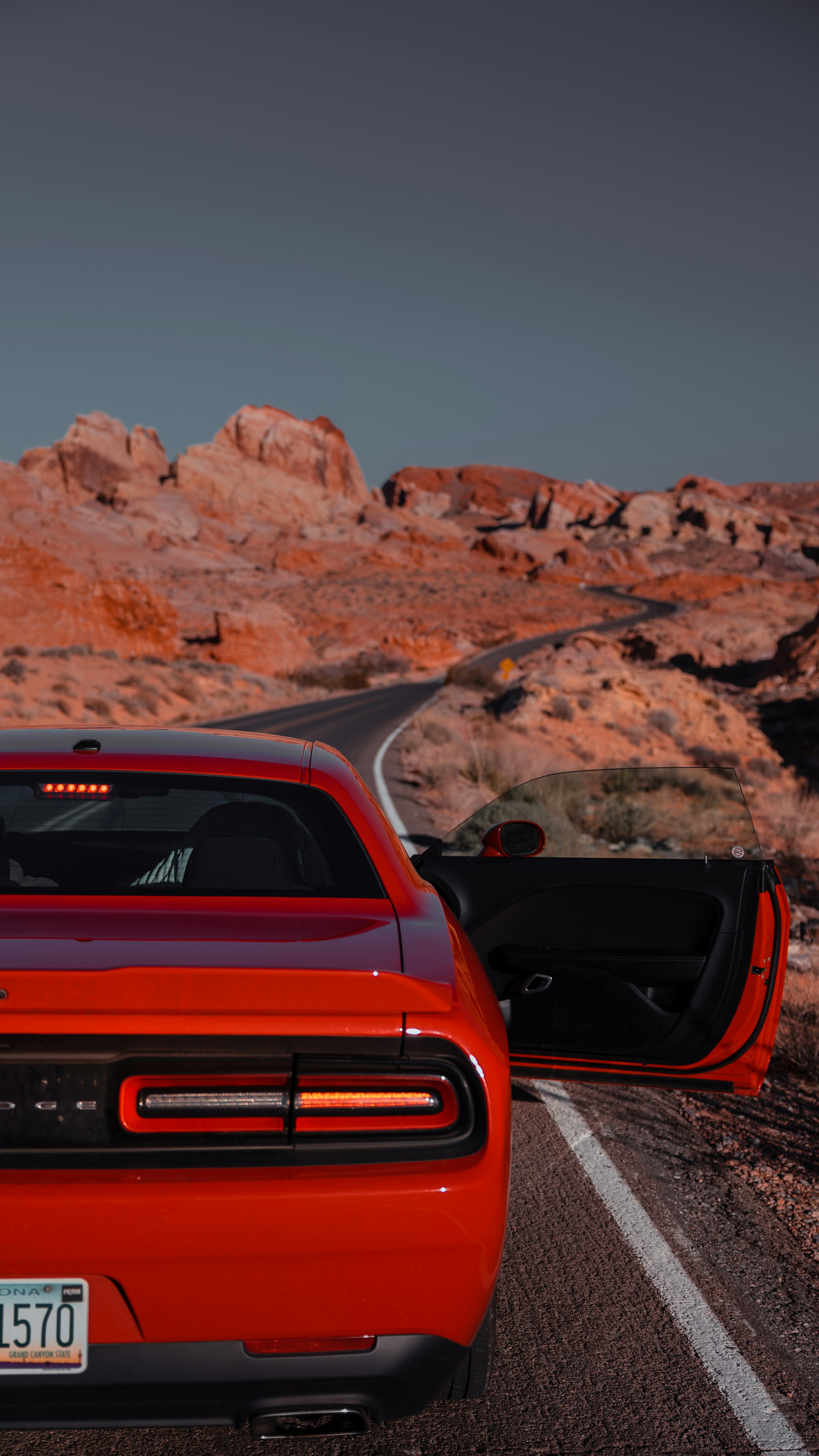 Desert Highway Red: Open-Door Challenger on a Winding Route