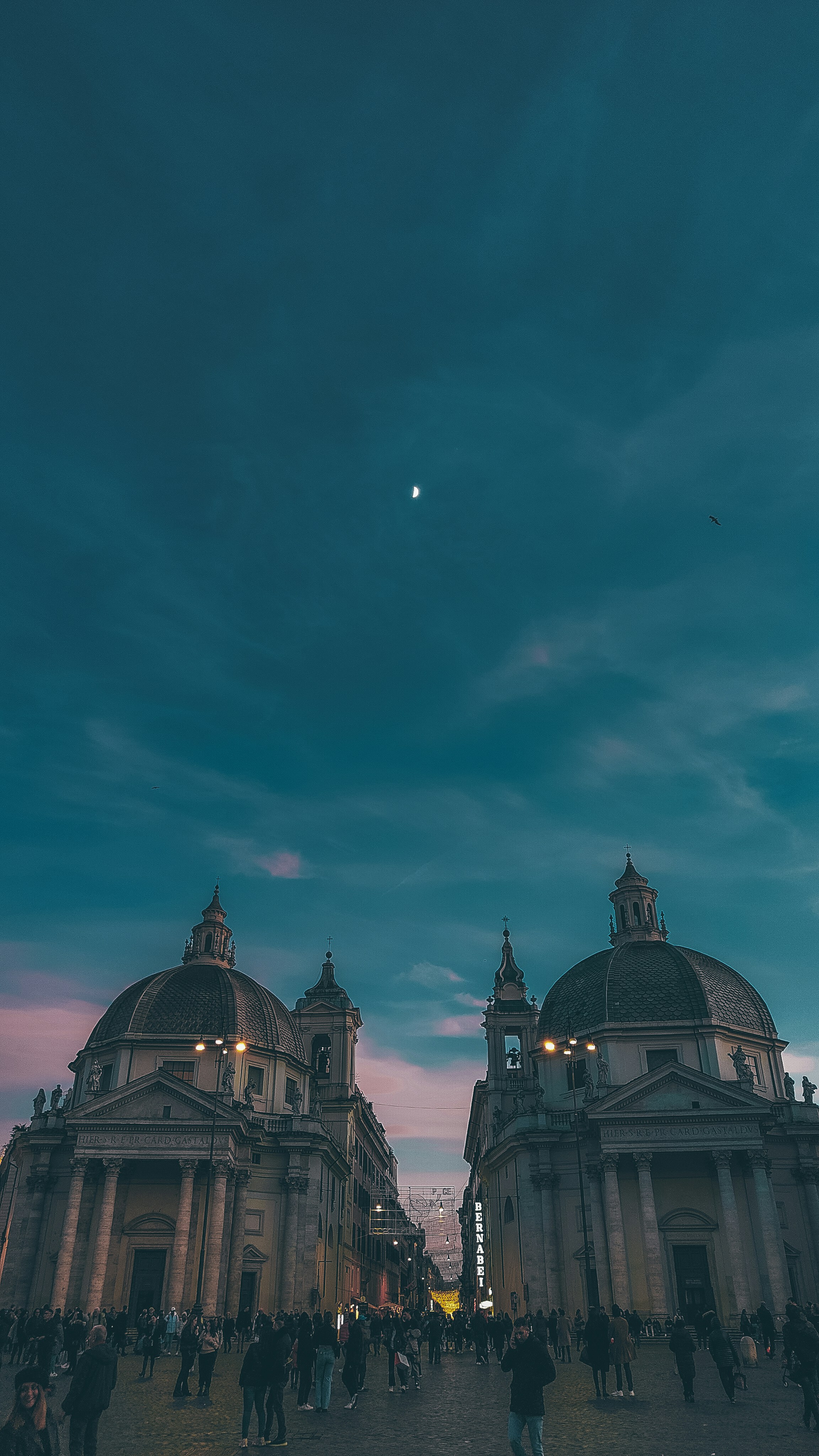 Twin Domes, Evening Sky: A Crowd Beneath Baroque Silhouettes