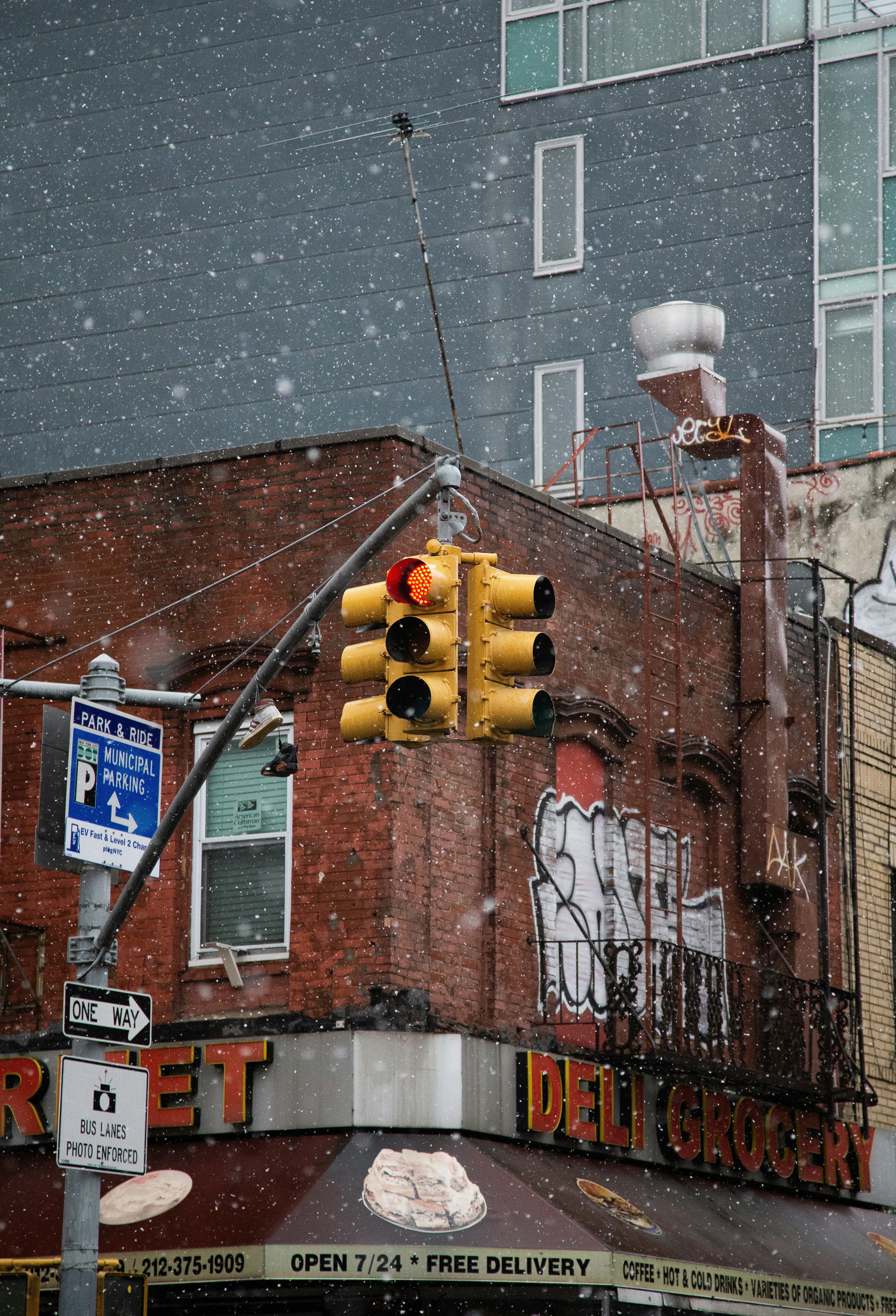 a traffic light hanging over a street next to a building